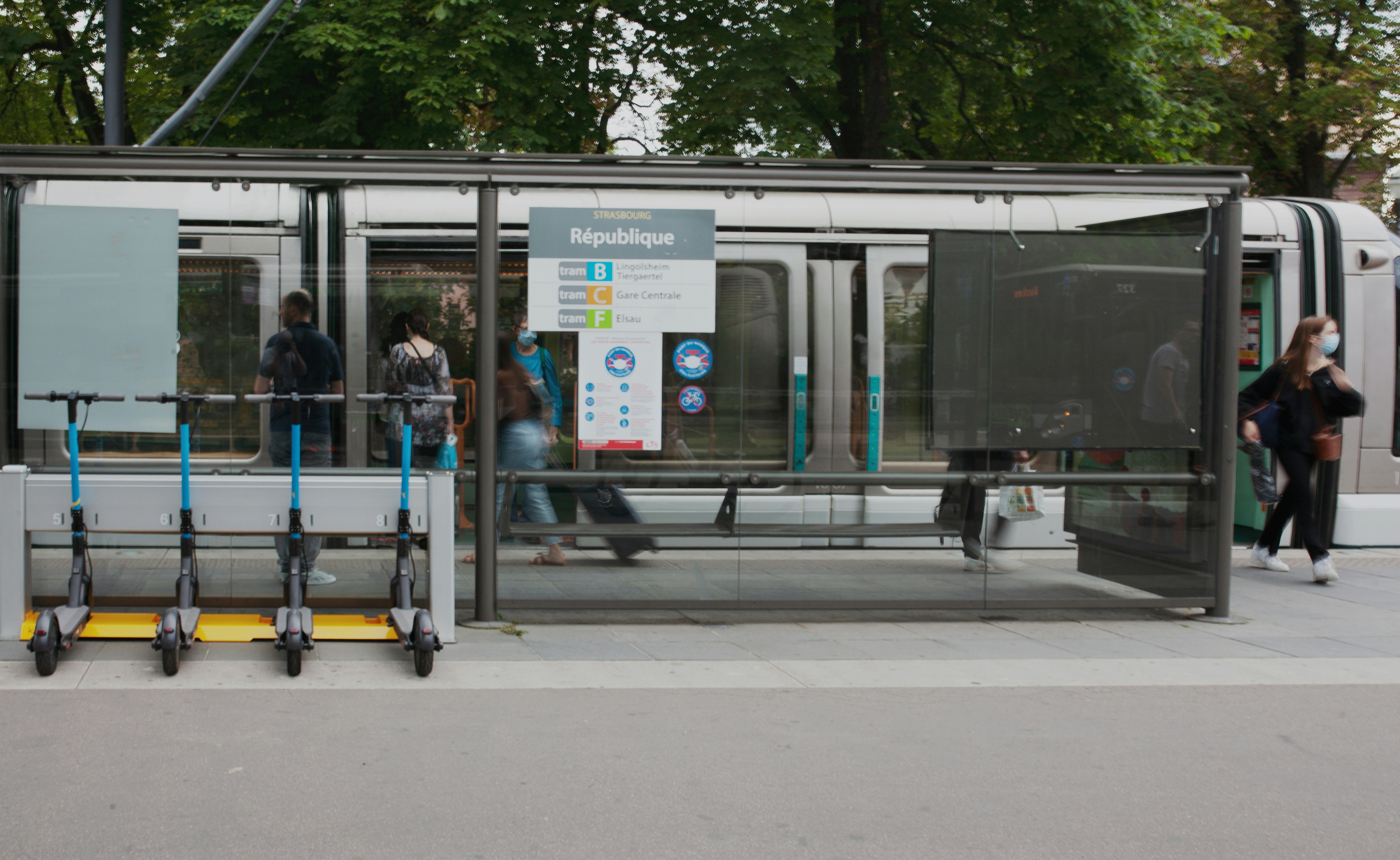 A bus stop with people waiting for the bus photo – Free Docking station ...