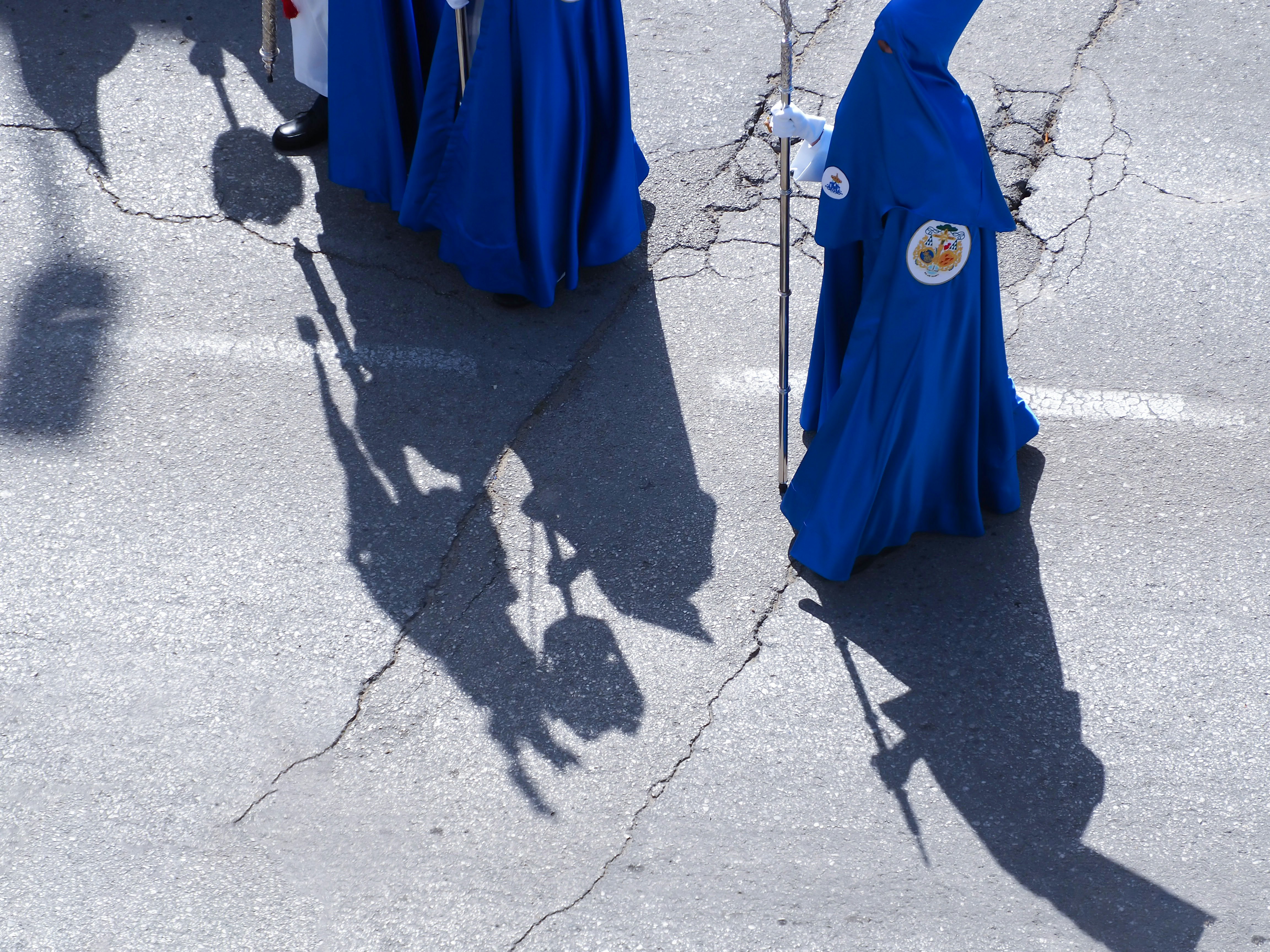 A couple of people in blue robes standing next to a fire hydrant photo ...