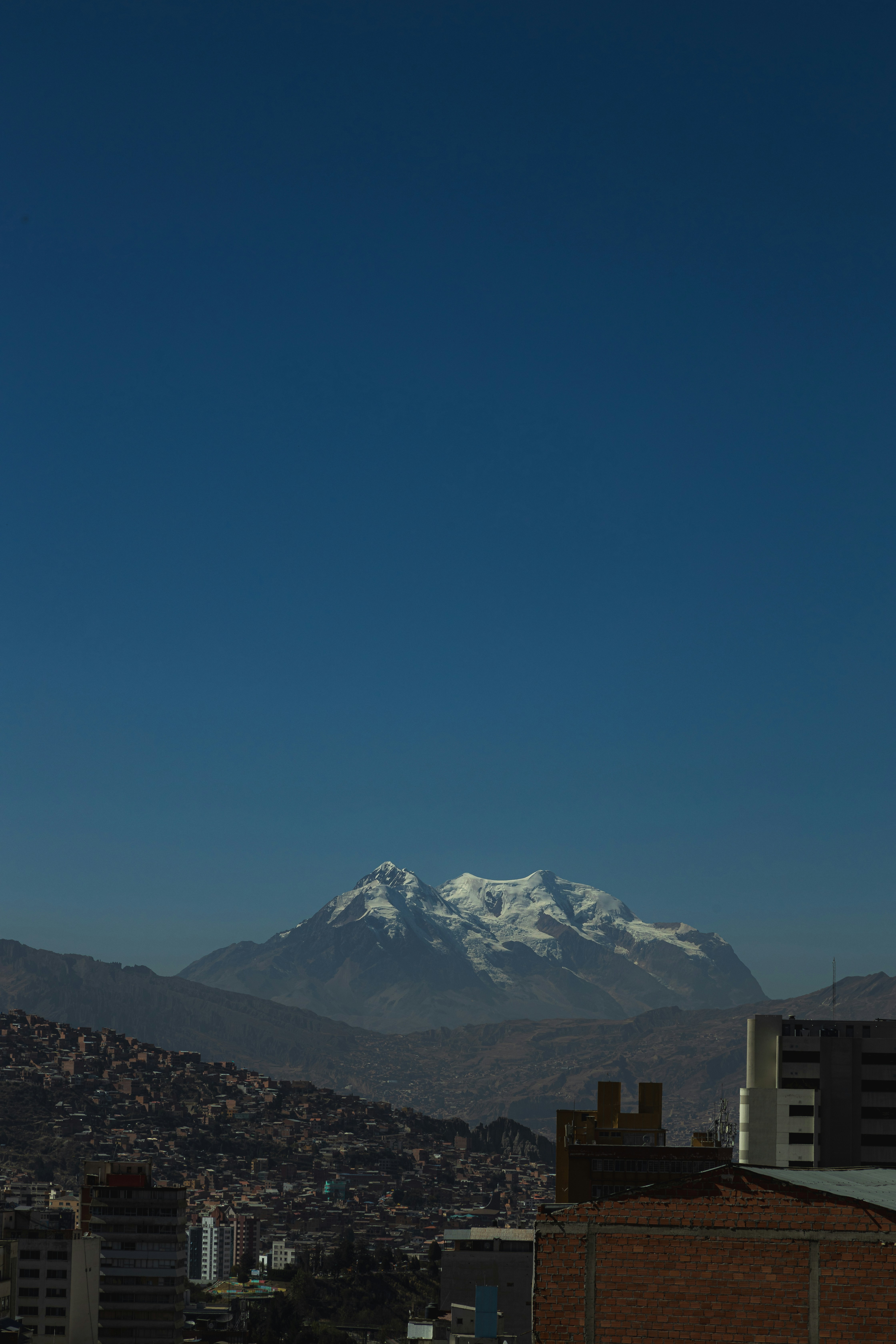 Snow-Capped Summit Over a Sea of Buildings
