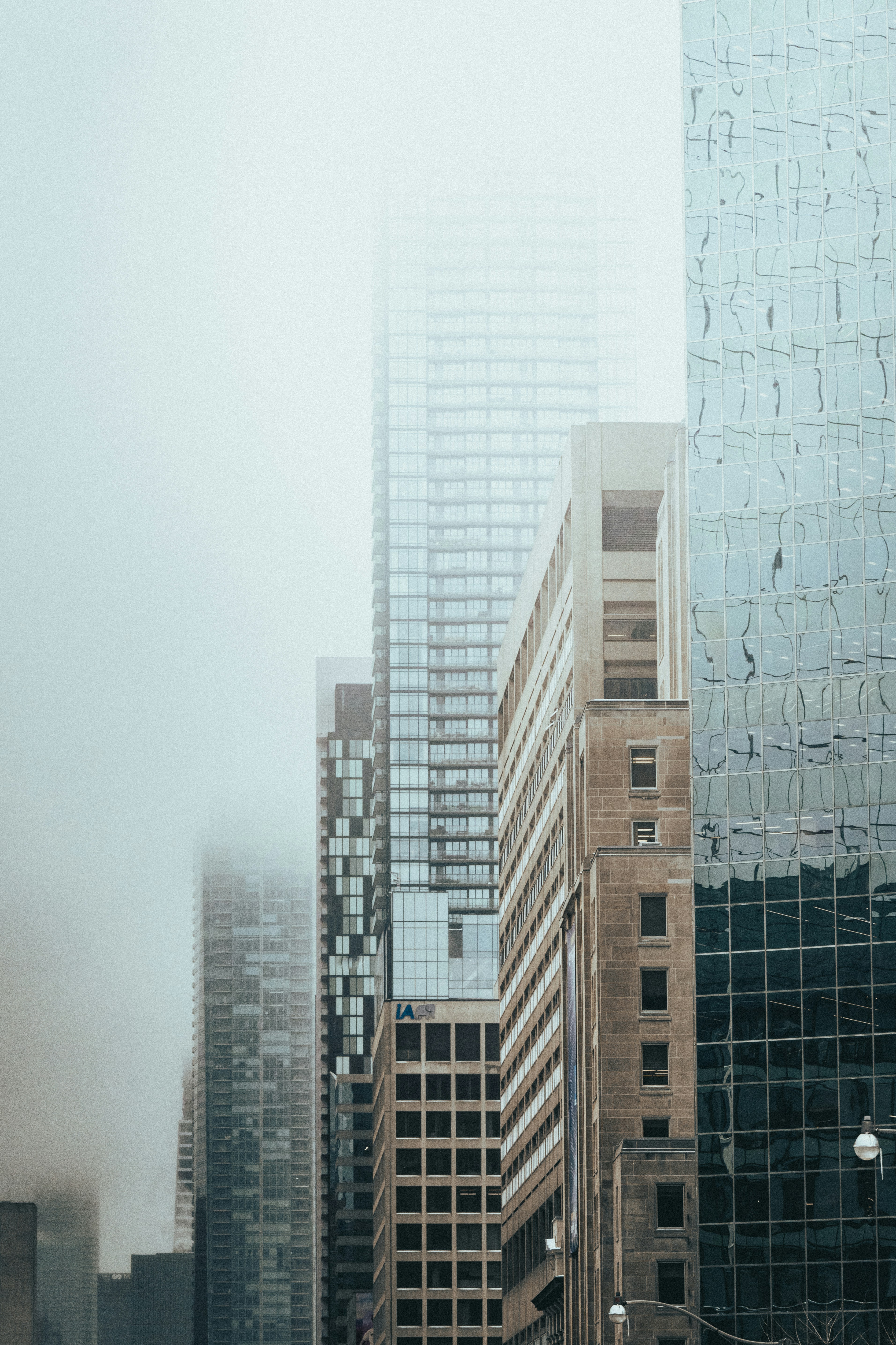A city street with tall buildings in the fog photo – Free Toronto Image ...