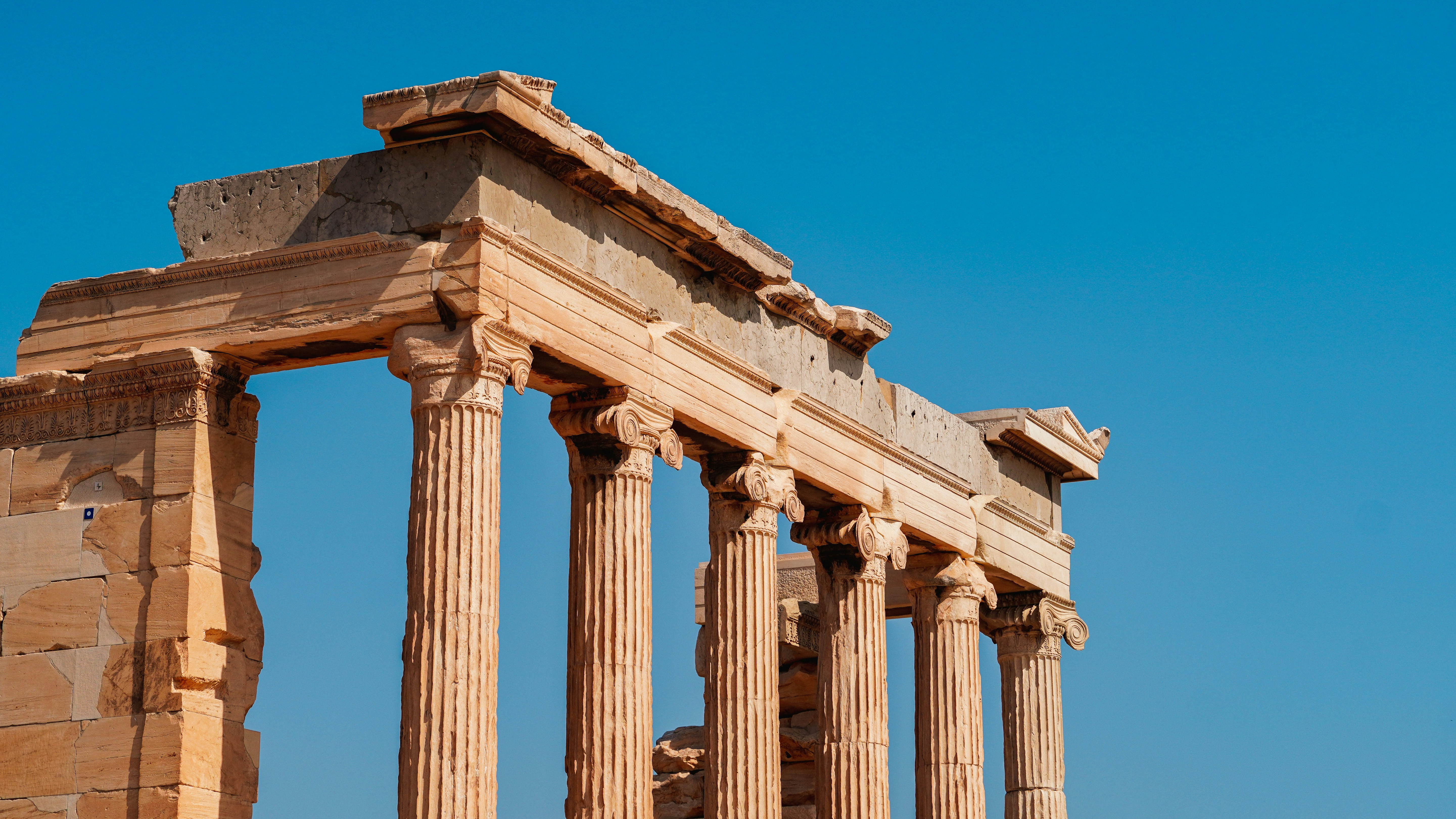 A tall stone structure with many columns photo – Free Grecia Image on ...