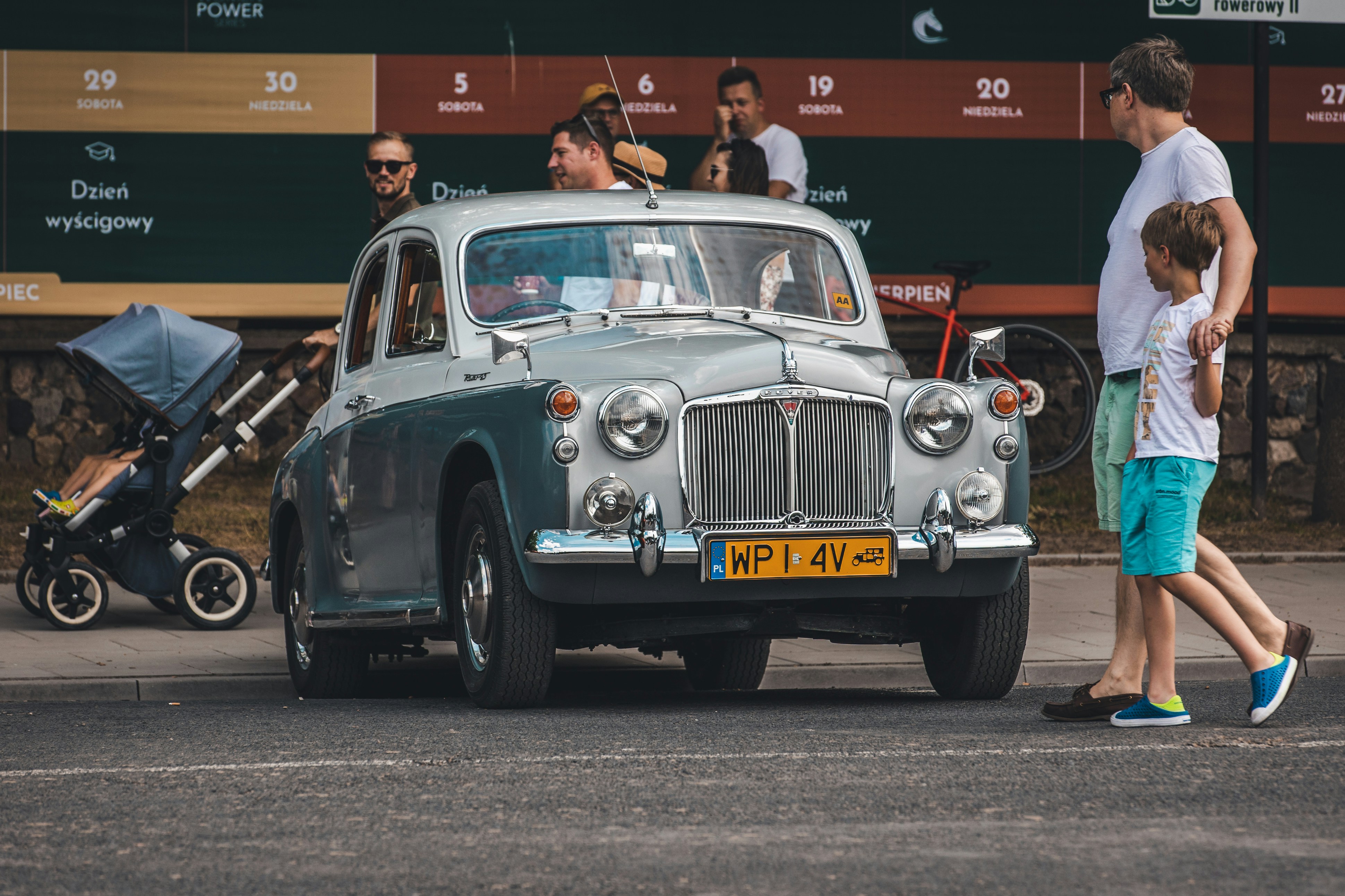 Polished Retro Sedan at a Bustling Urban Crossroad