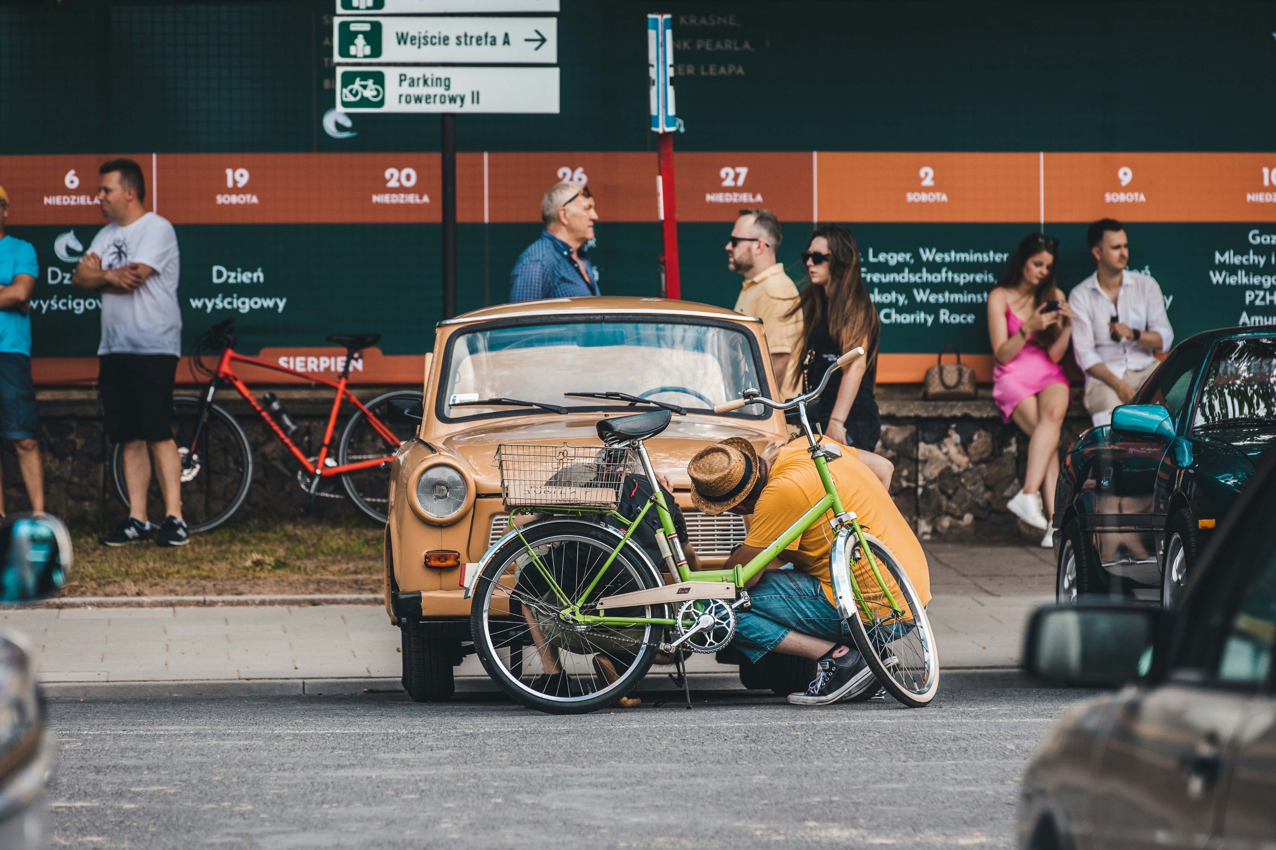 Vintage Car Meet: A Lime-Bloom Bicycle Resting Against a Classic Sedan
