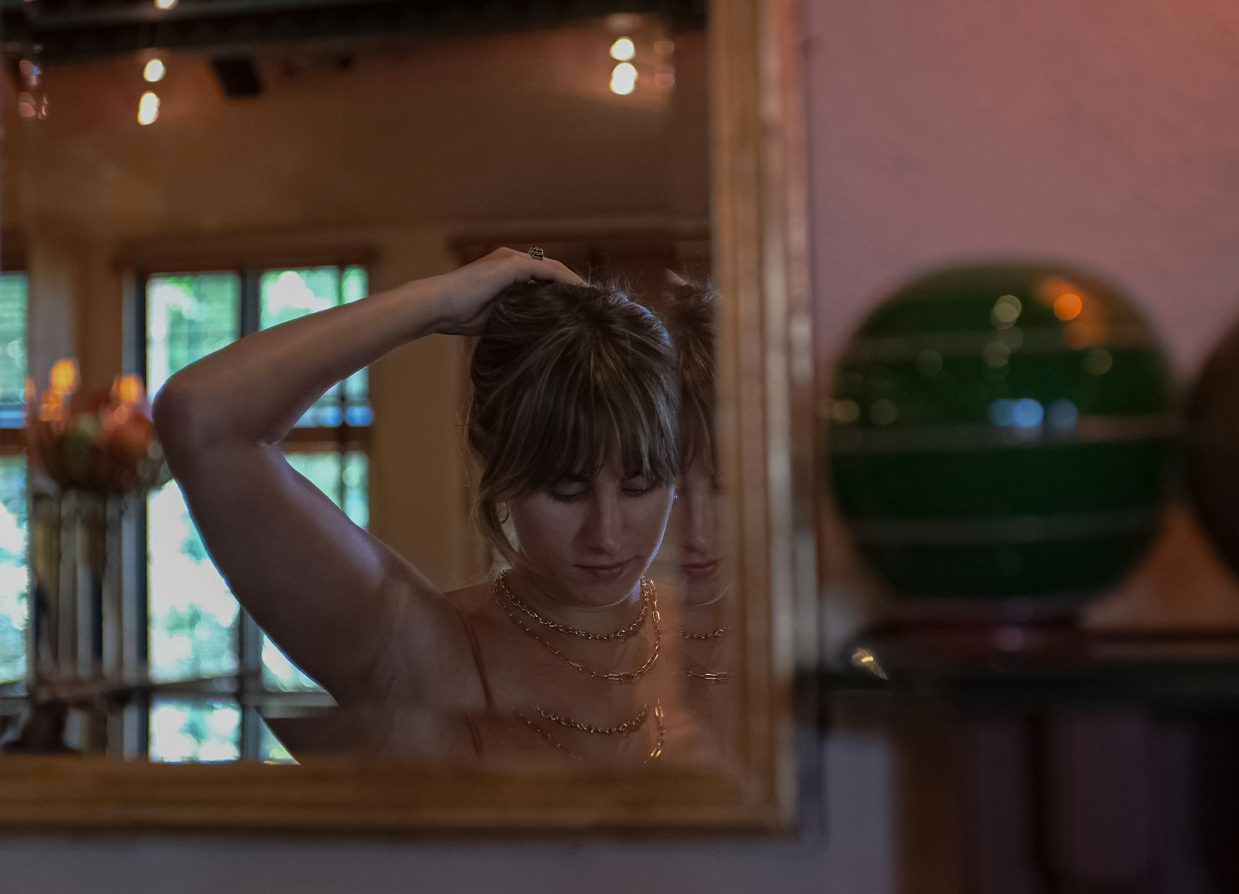 Warm Reflections: A Quiet Portrait in a Dimly Lit Mirror