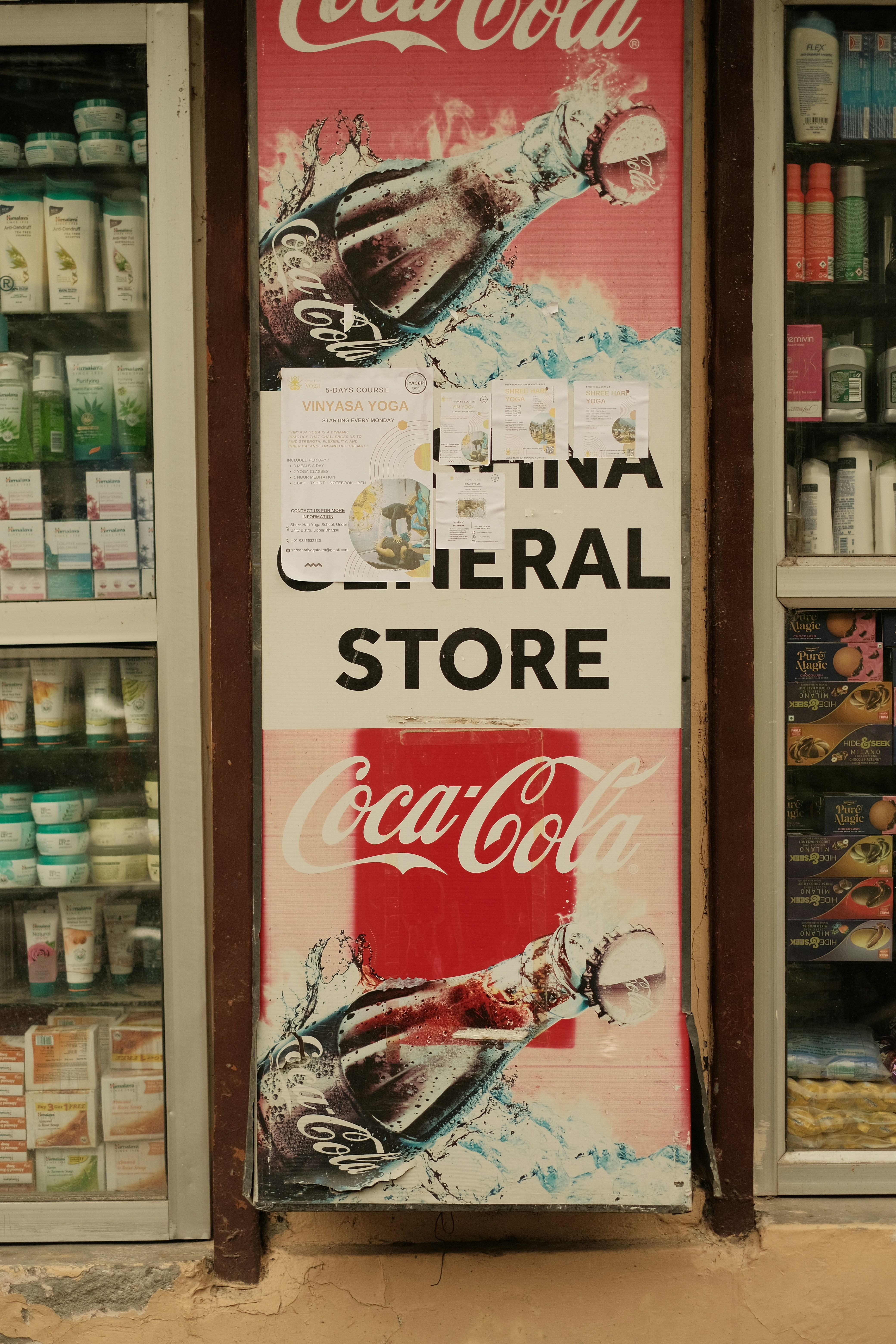 A coca - cola sign in front of a store photo – Free Travel Image on ...