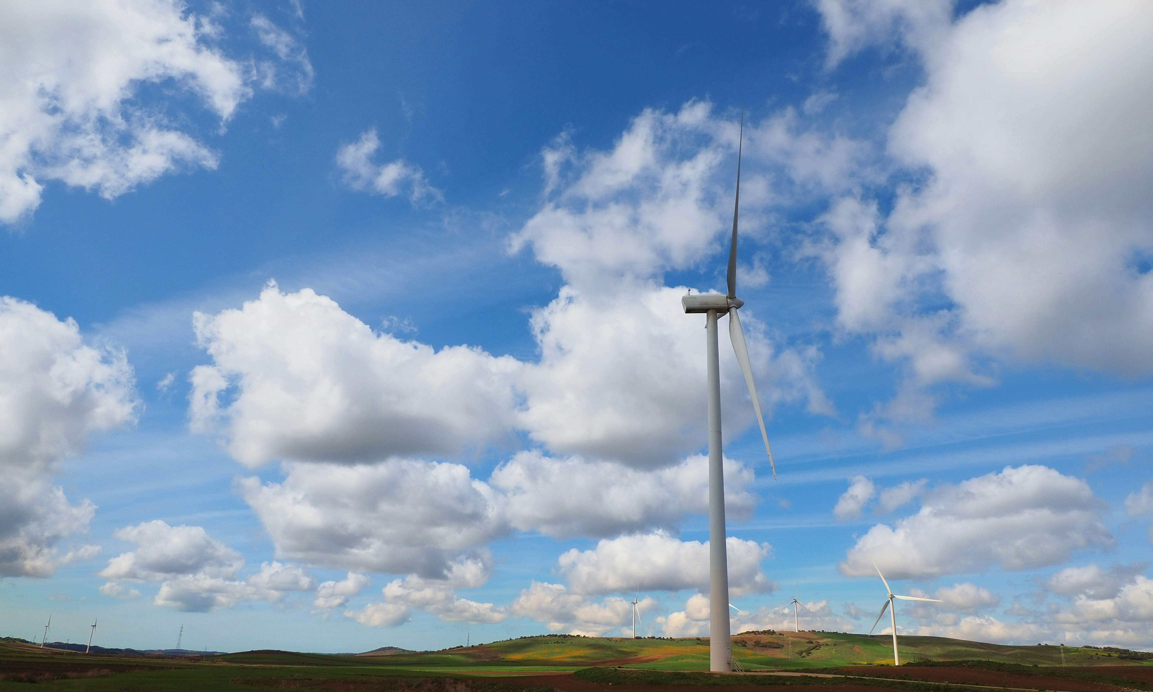A wind turbine in the middle of a field photo – Free Outdoors Image on ...