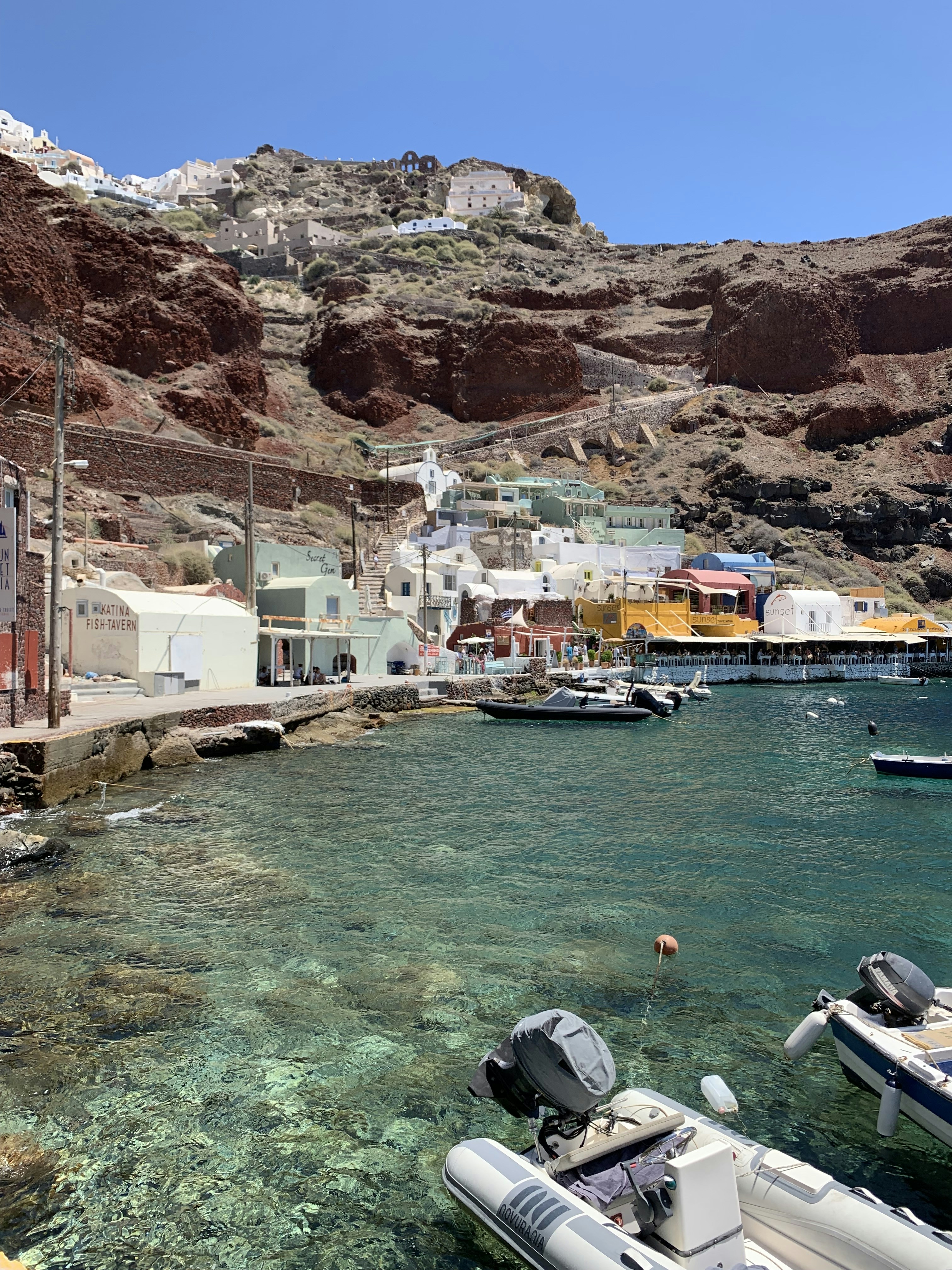 A body of water that has boats in it photo – Free Oia harbor Image on ...