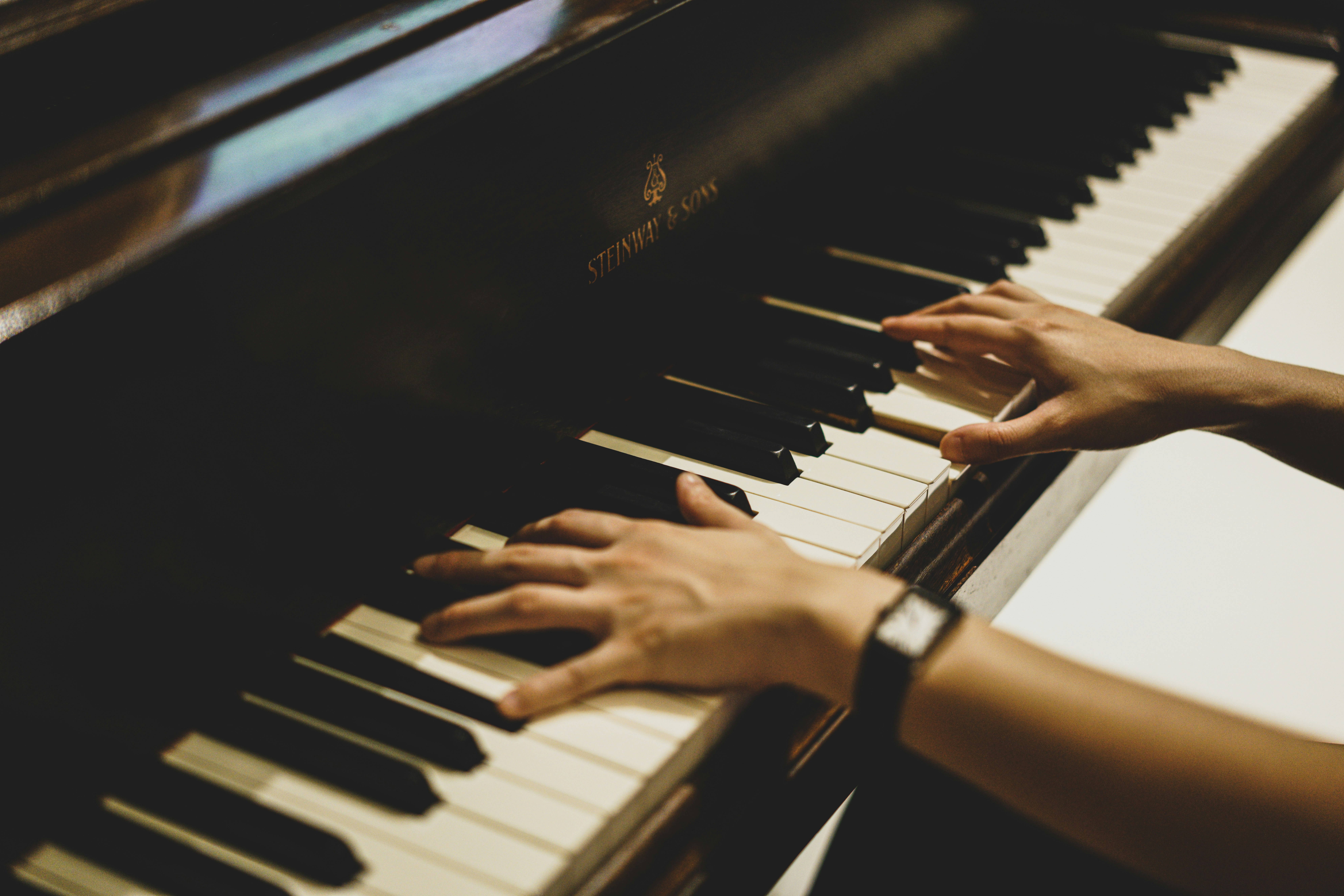 A person playing a piano with their hands photo – Free Music Image on ...