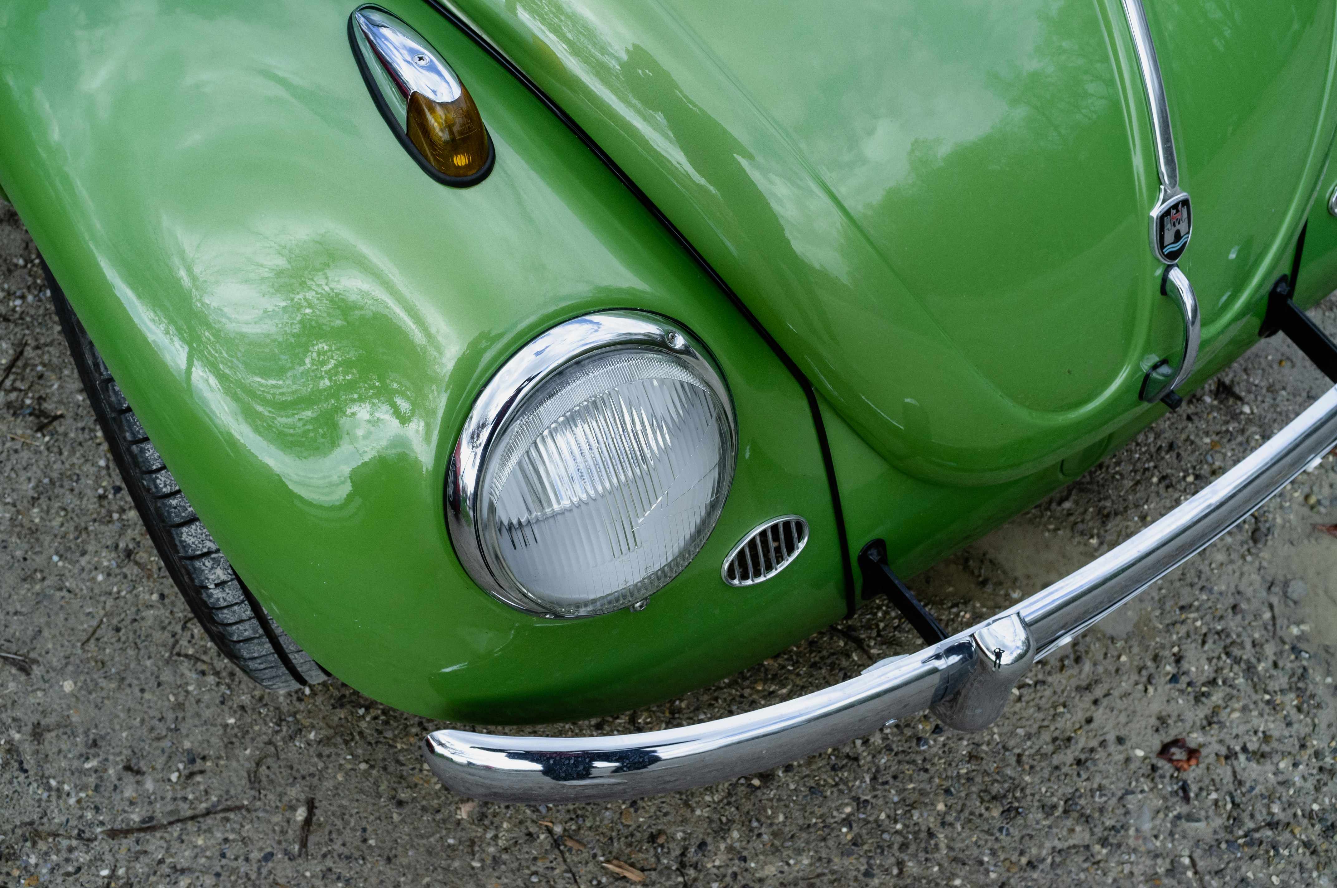 Lime Vintage Close-Up: Chrome Curves of a Beetle's Front End