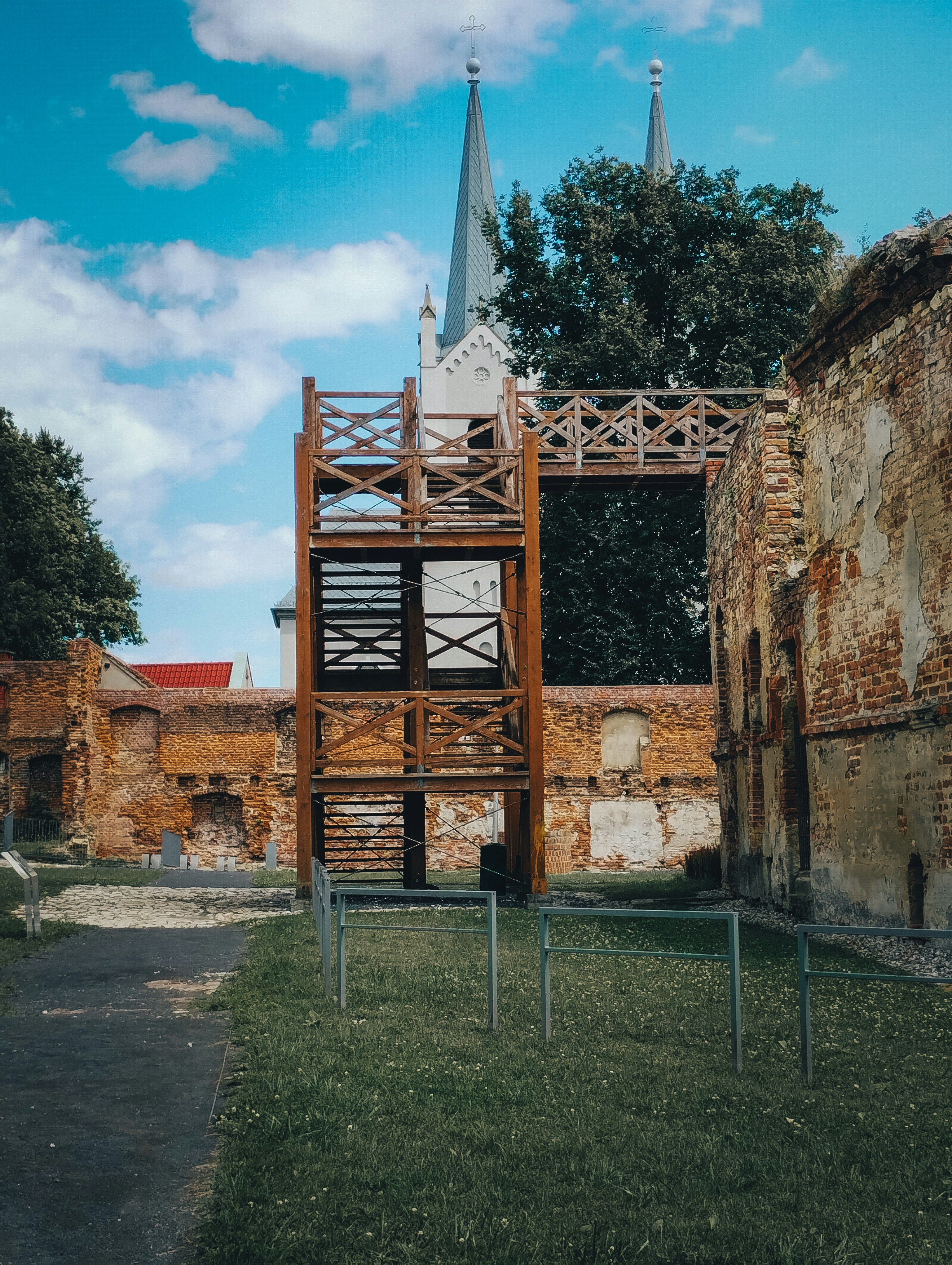 A Timber Stairway Over Ruins Under a Clear Sky