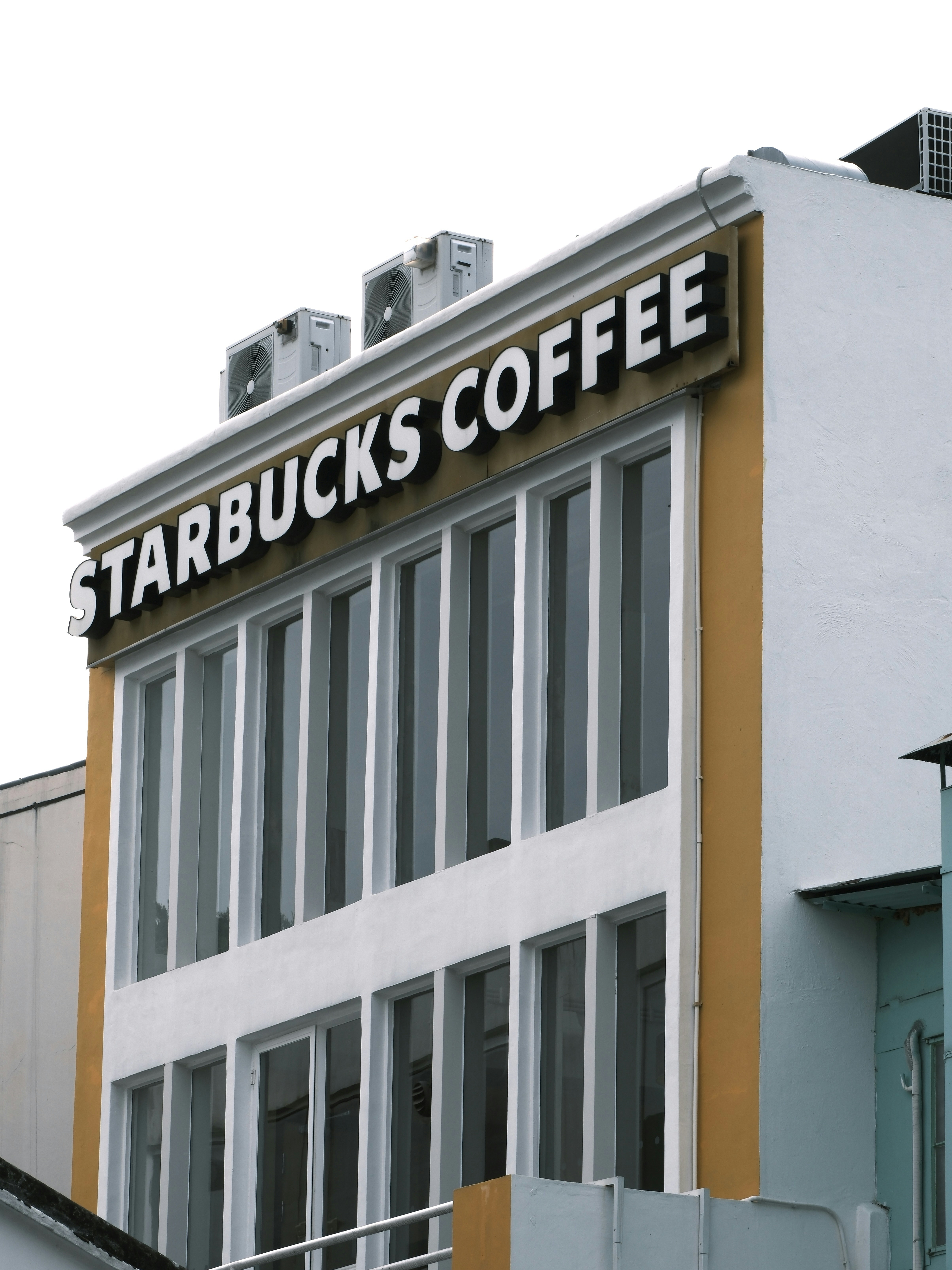 A starbucks building with a sign that says starbucks's coffee photo ...