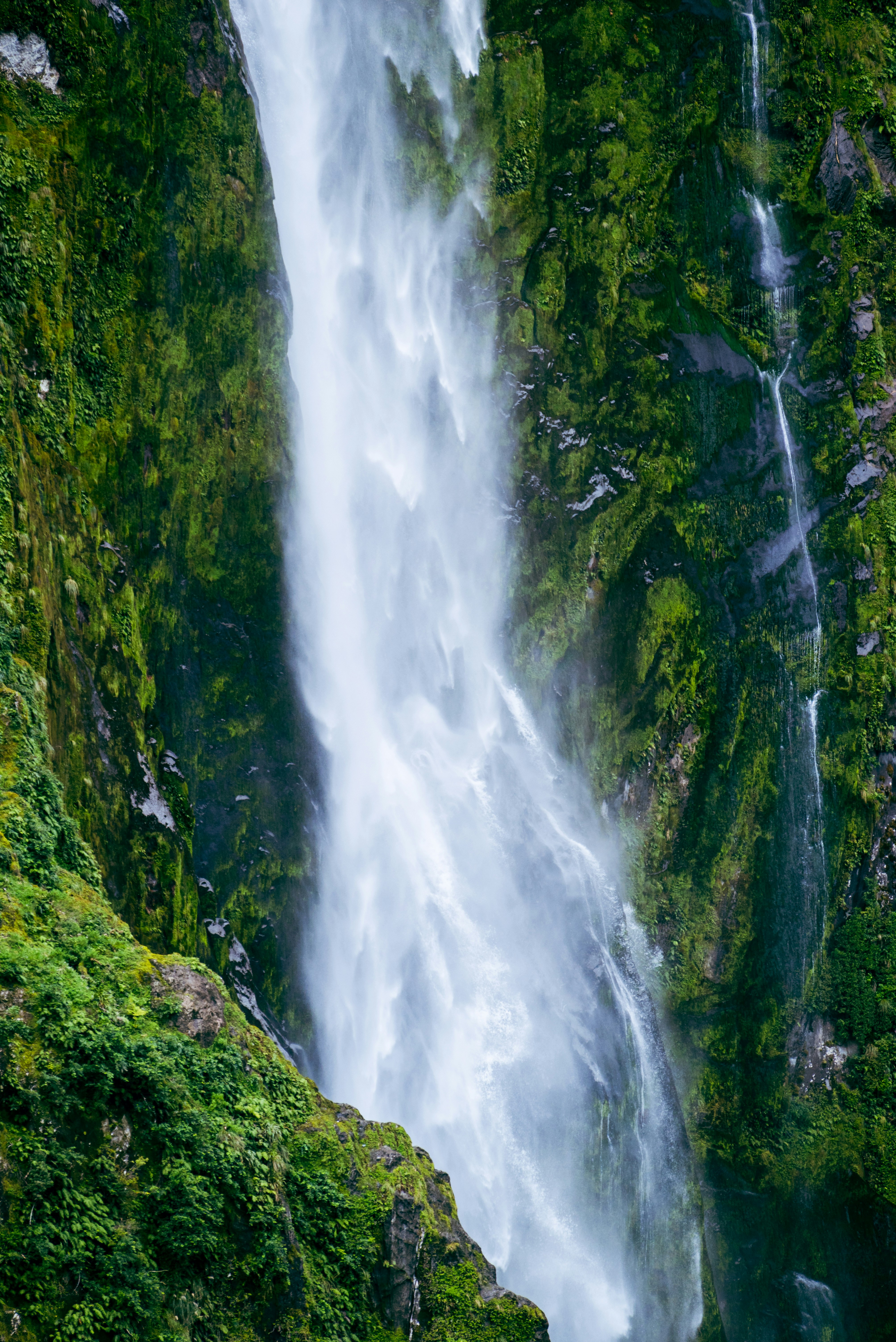 A waterfall in the middle of a lush green forest photo – Free Waterfall ...