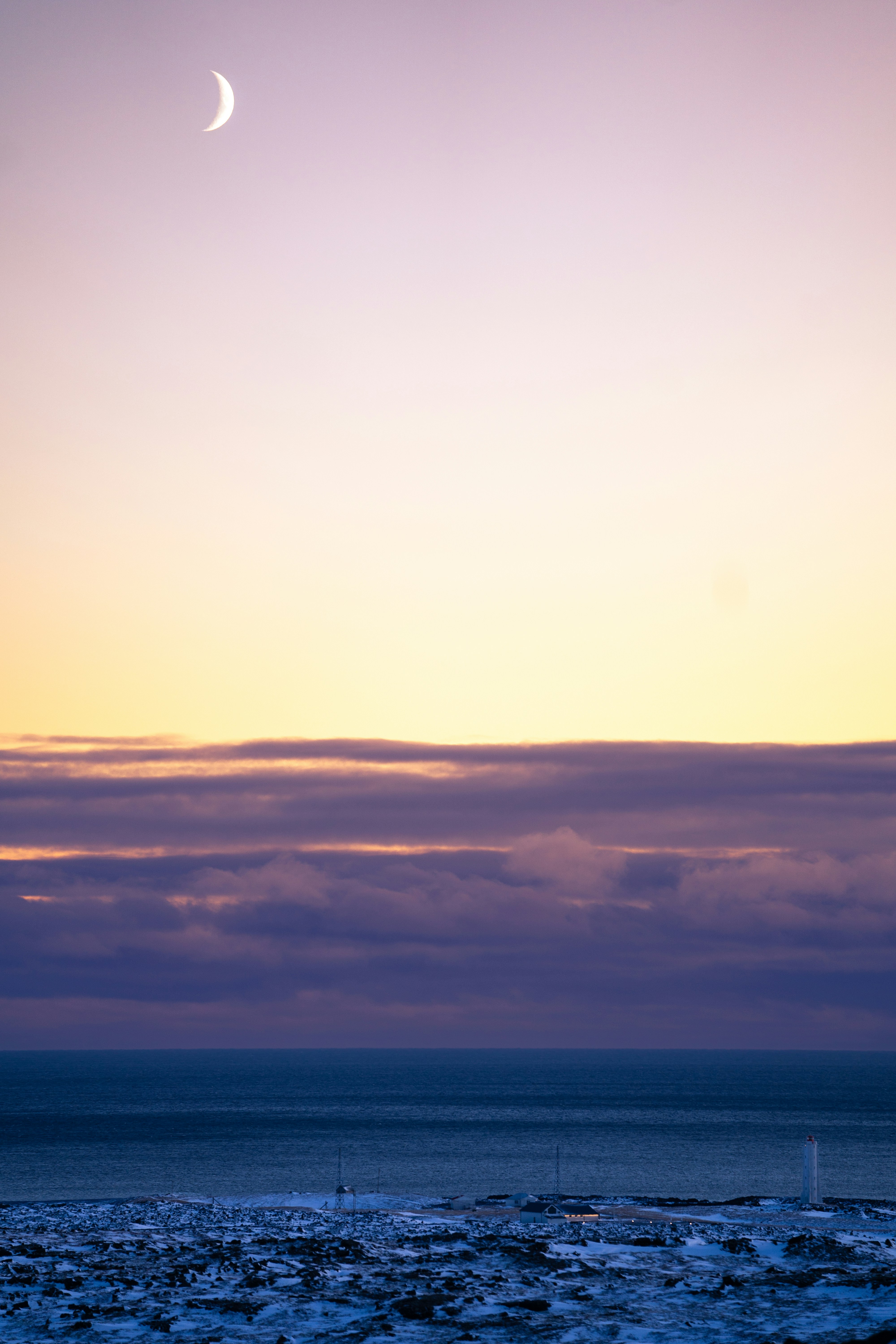 The moon is setting over the ocean on a cloudy day photo – Free Nature ...