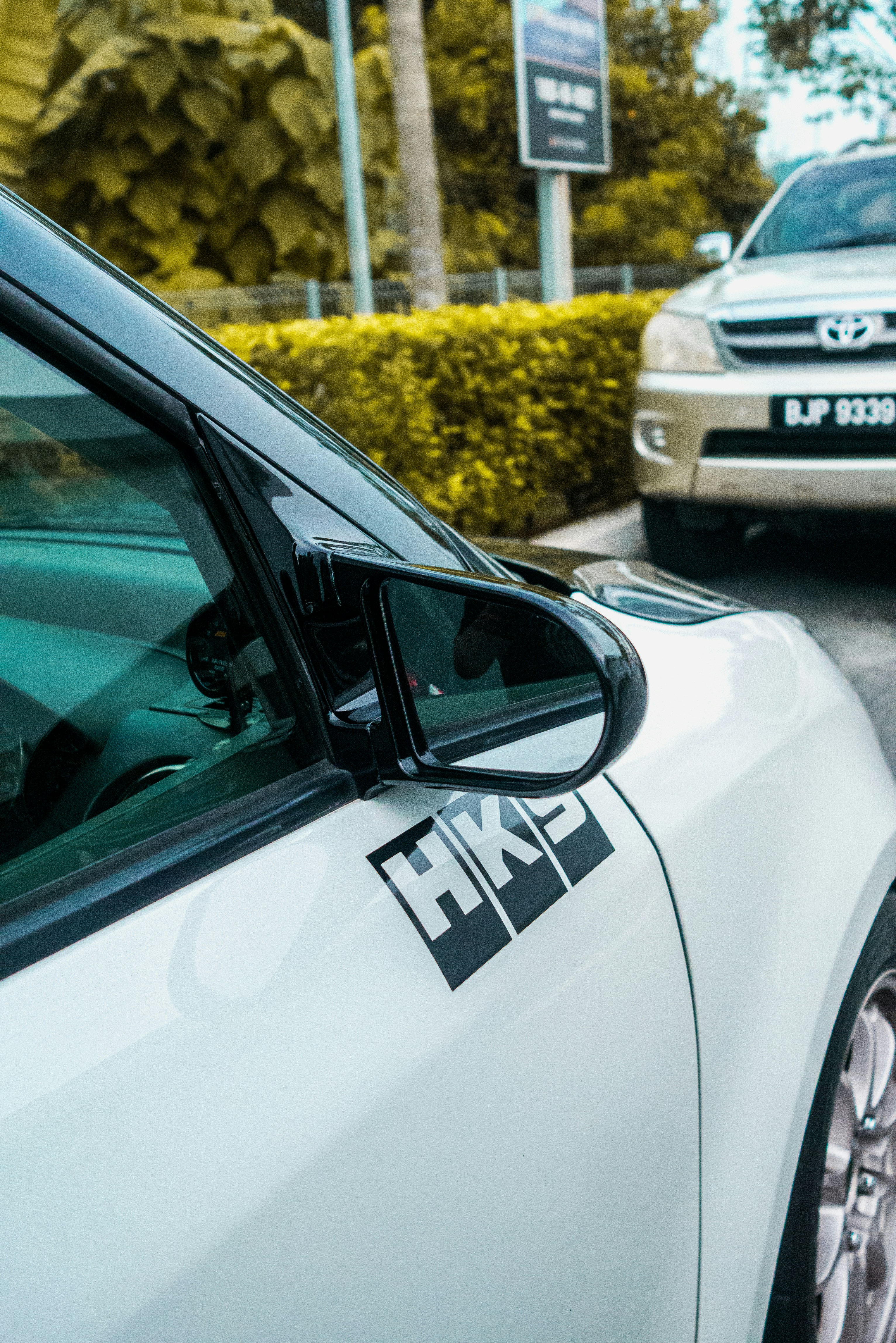 Edge of Authority: Close-Quarter Shot of a Patrol Car's Side Mirror
