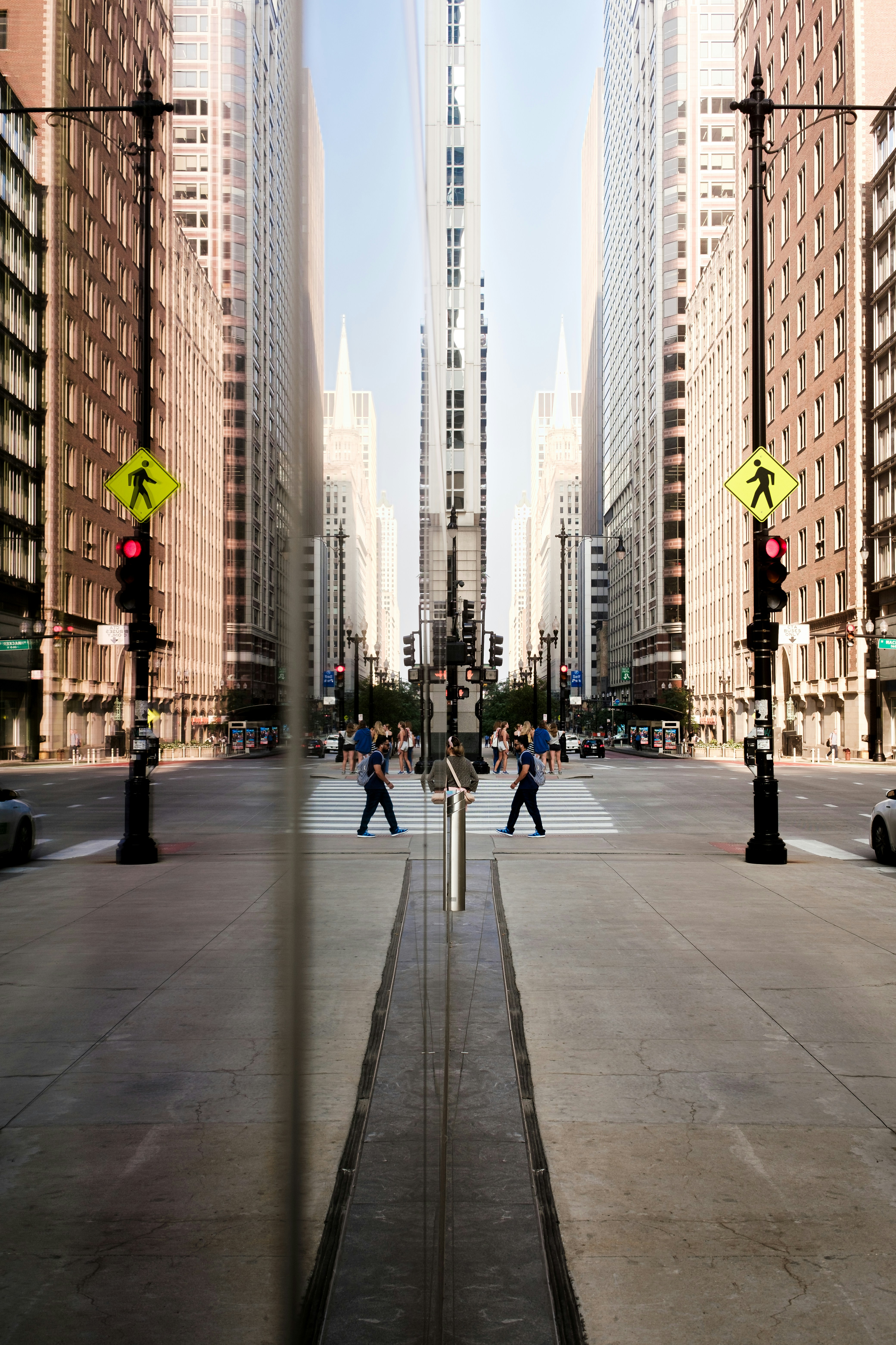 Symmetry on the City Axis: Pedestrians Crossing a Glass-Lined Street