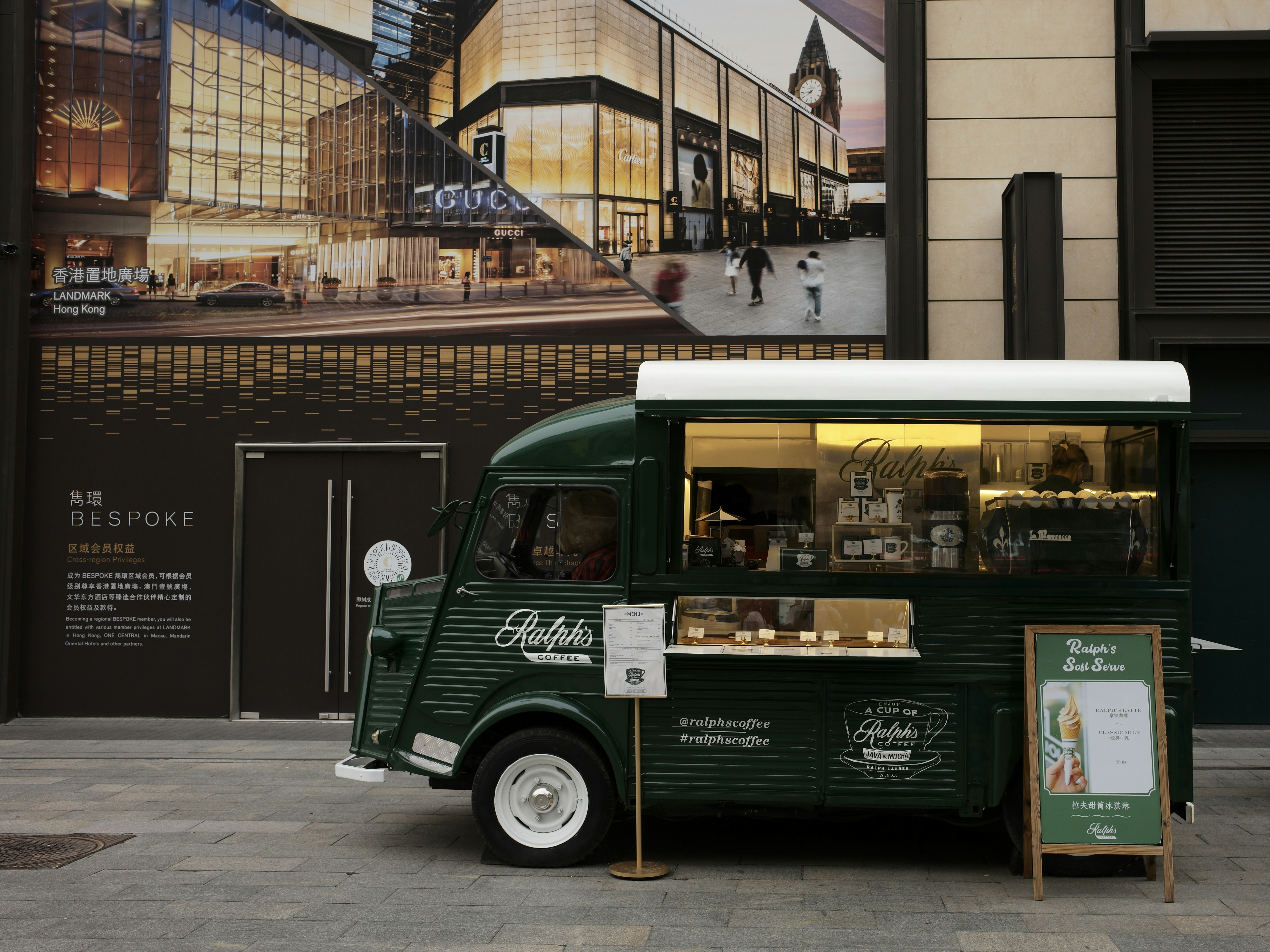 Green Vintage Food Truck by a Gucci storefront mural