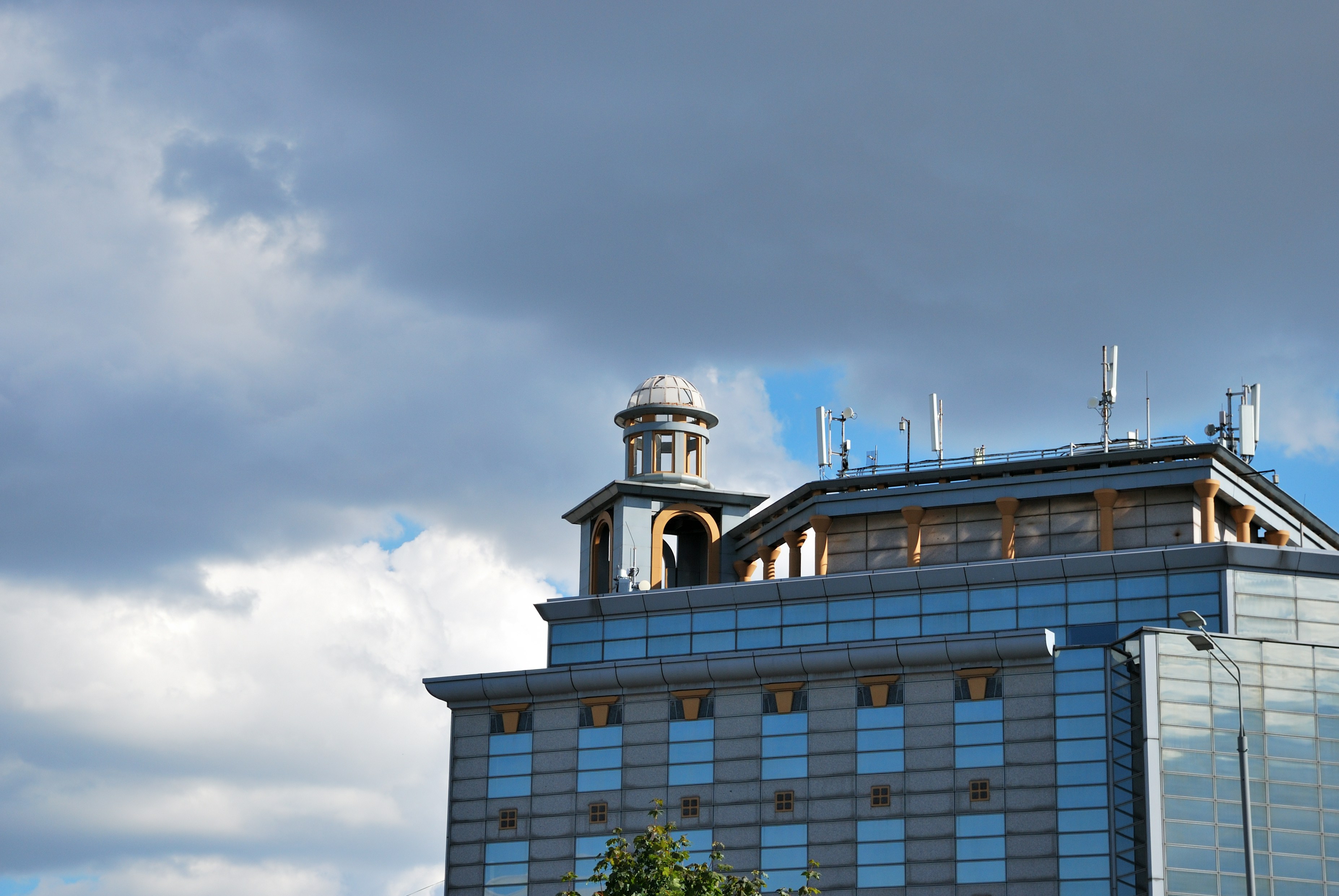 Towering Rooftop Lanterns Above Glass Facade