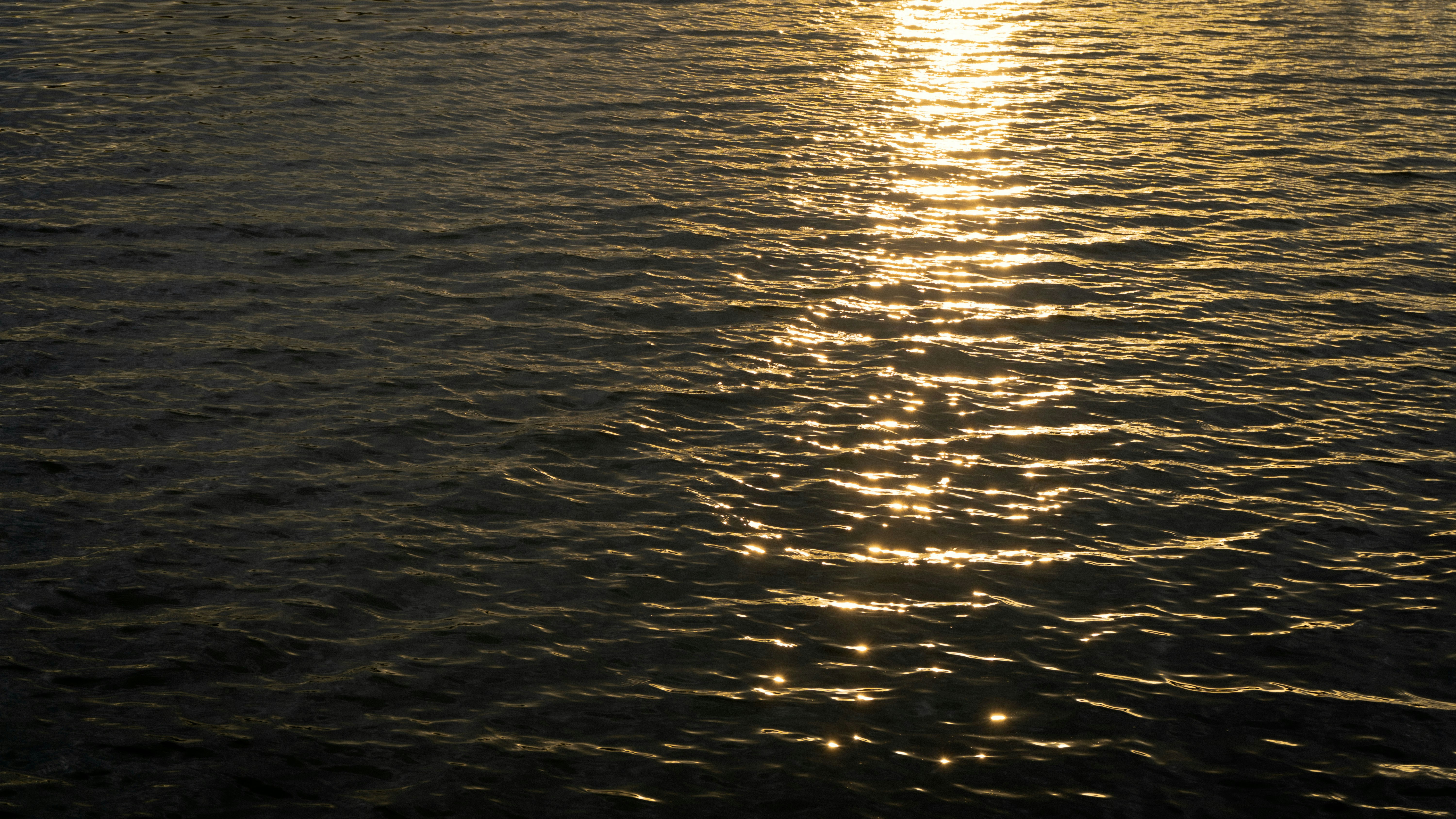 A large body of water with a boat in the distance photo – Free Sony a ...