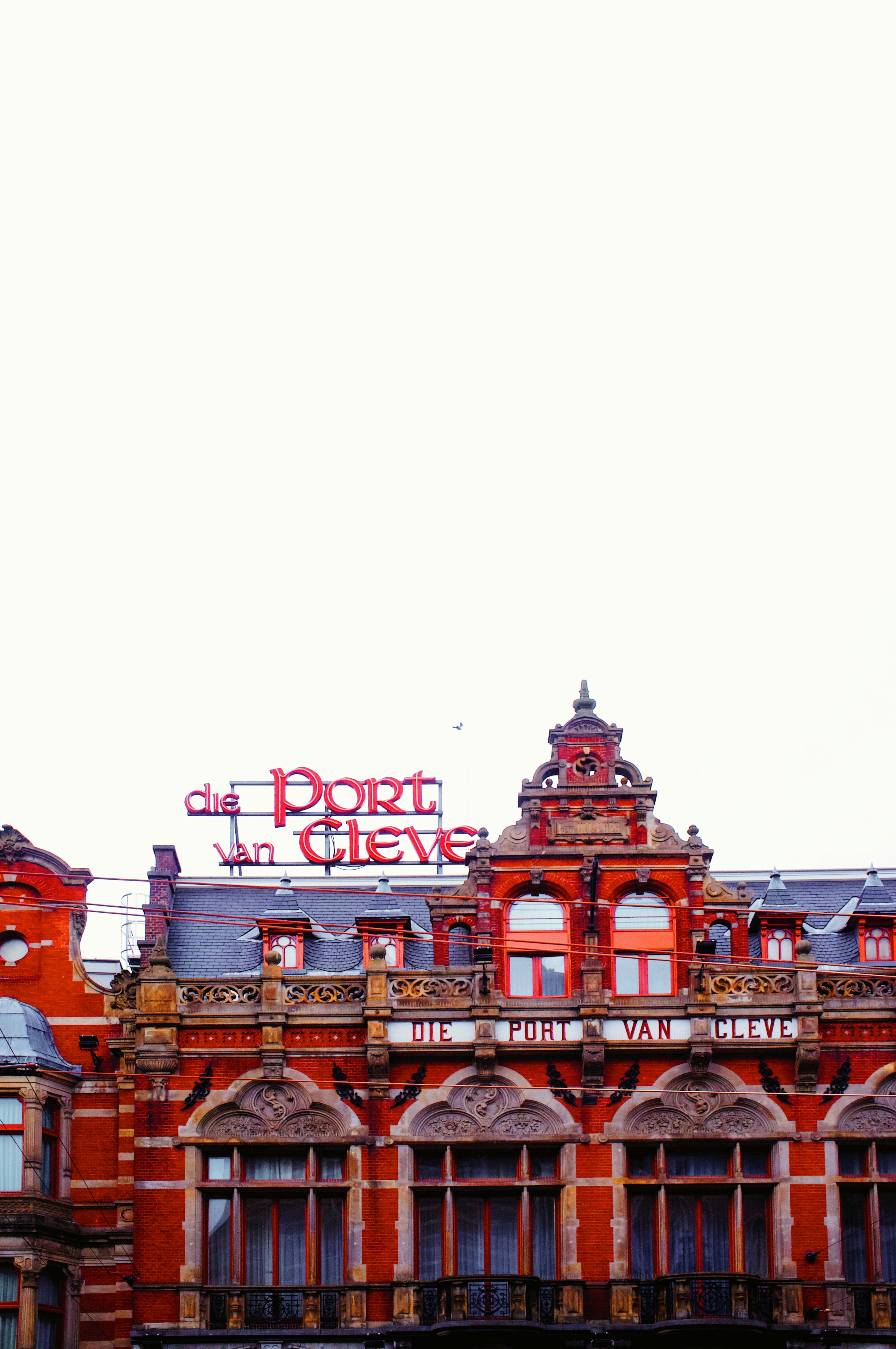A large red building with a sign on top of it photo – Free Building ...