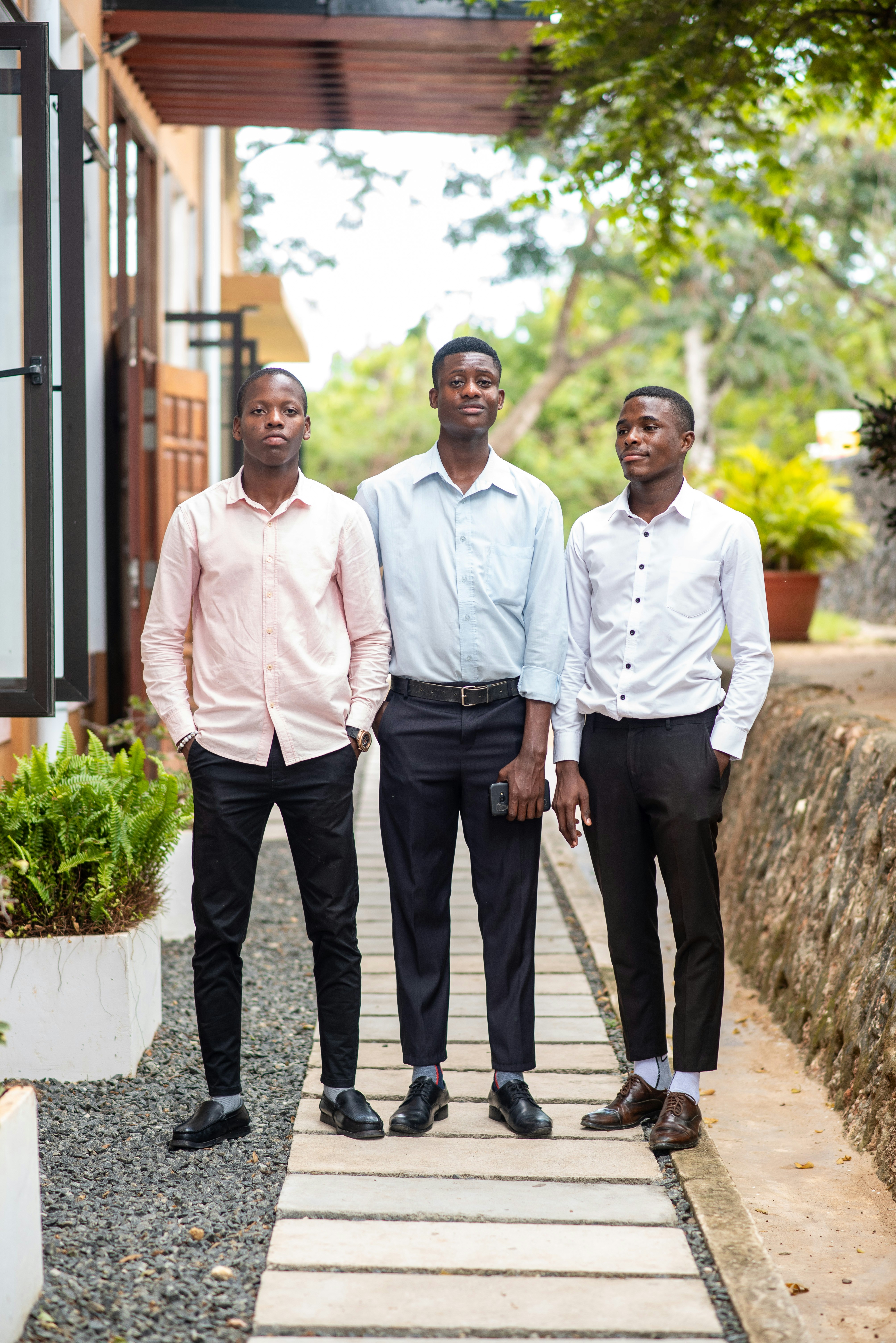 A group of three men standing next to each other photo – Free Makongo ...