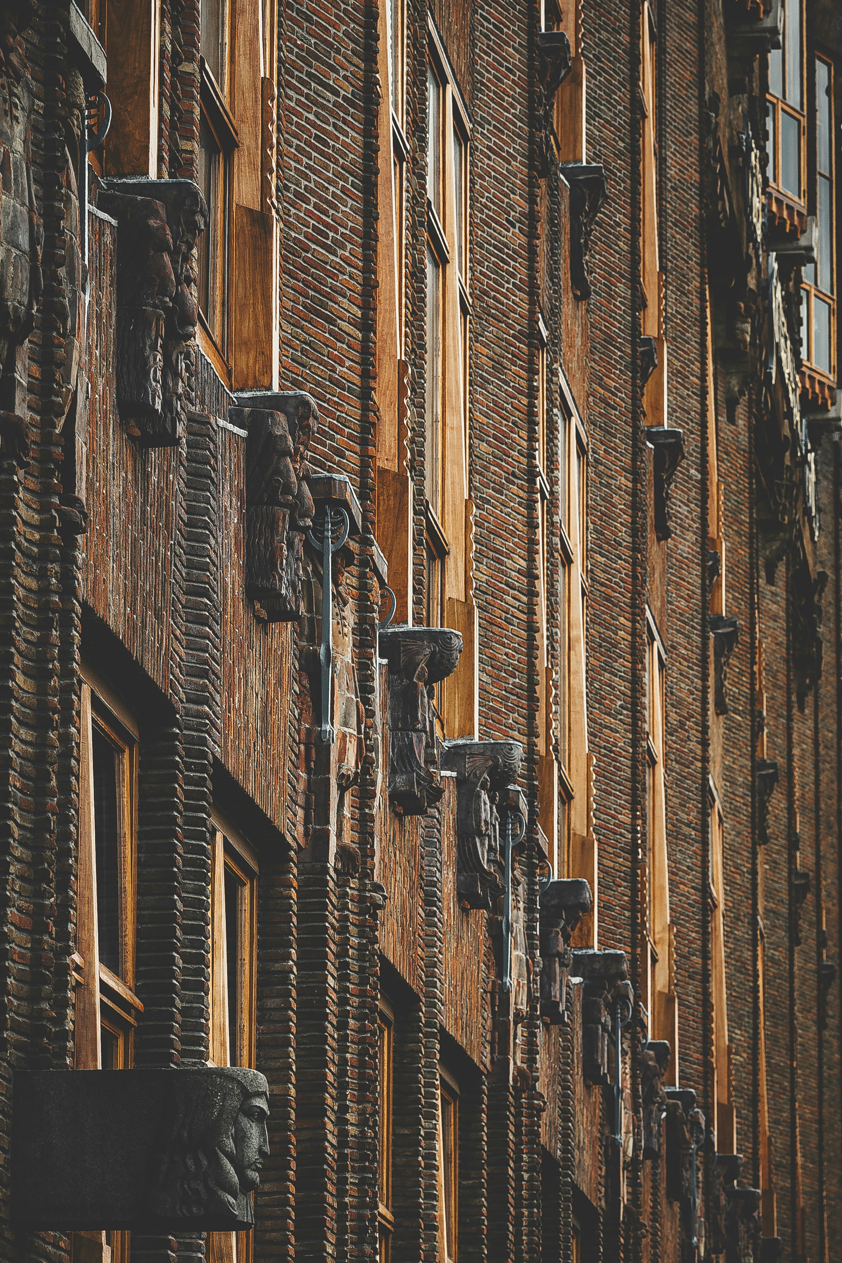 Vertical Rhythm: Repeating Cornices on a Sunlit Brick Facade