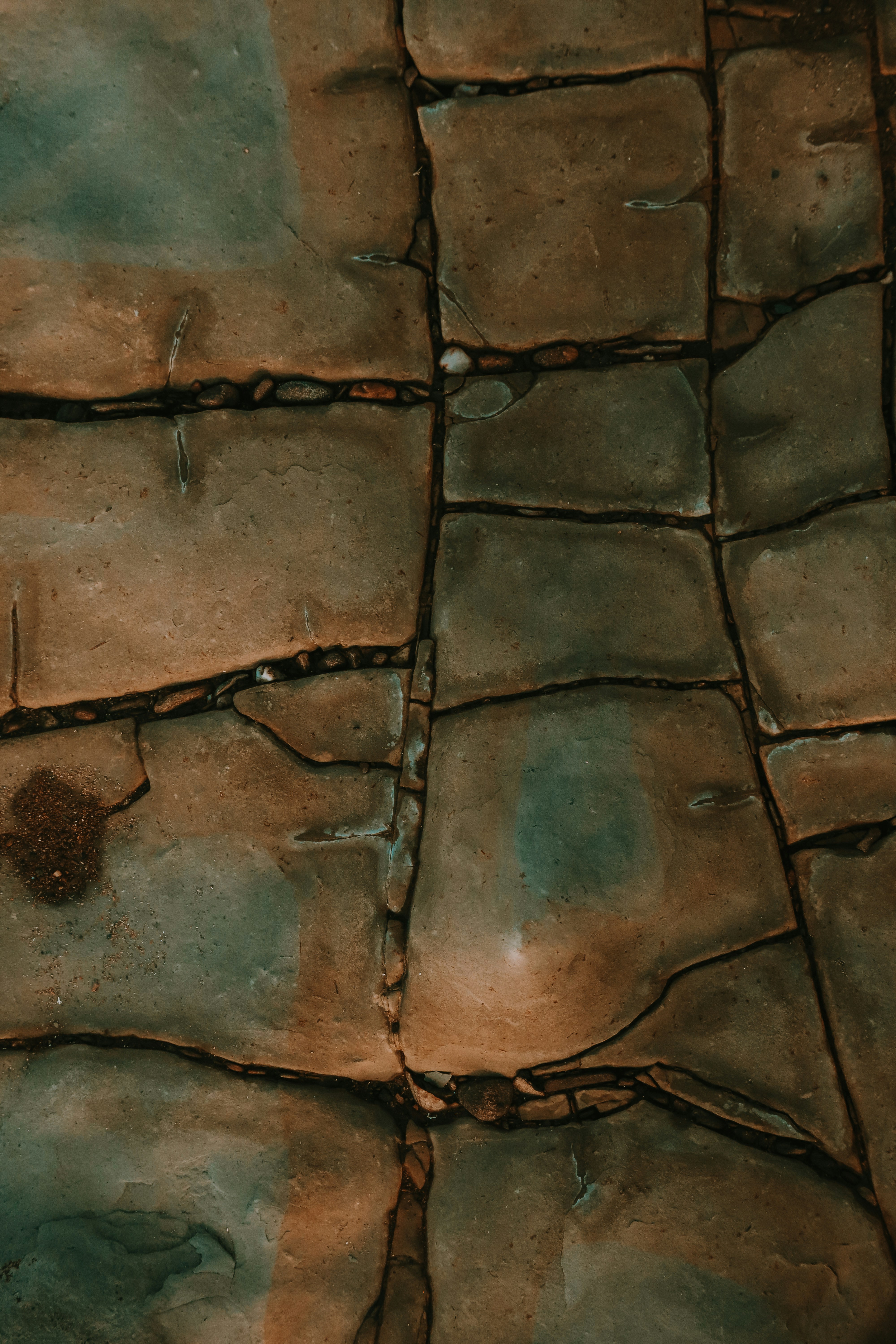 Moss-Tinted Cobblestones: A Quiet Grid of Weathered Tiles