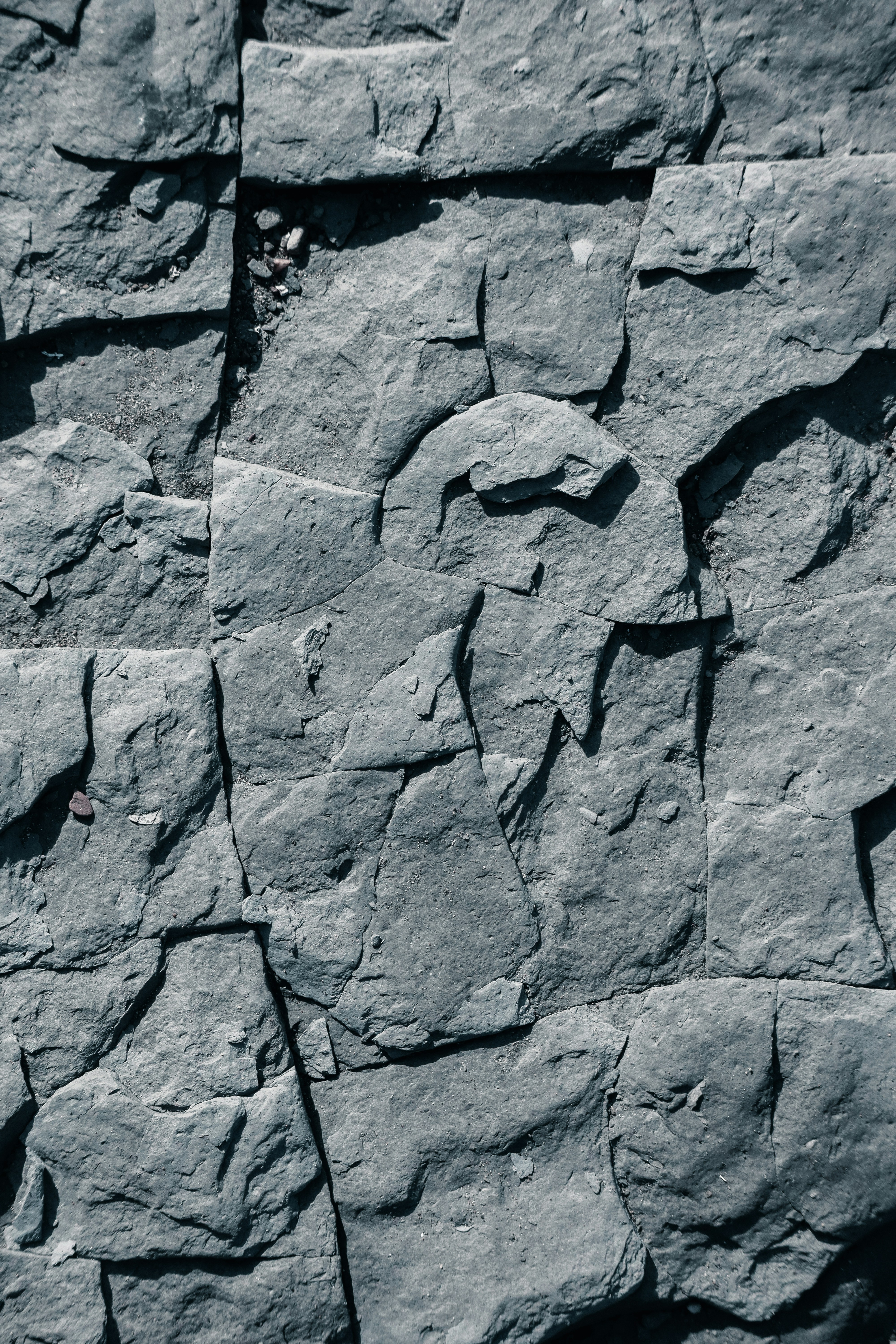 Geometric Granite: Weathered Facade of a Cracked Rock Wall