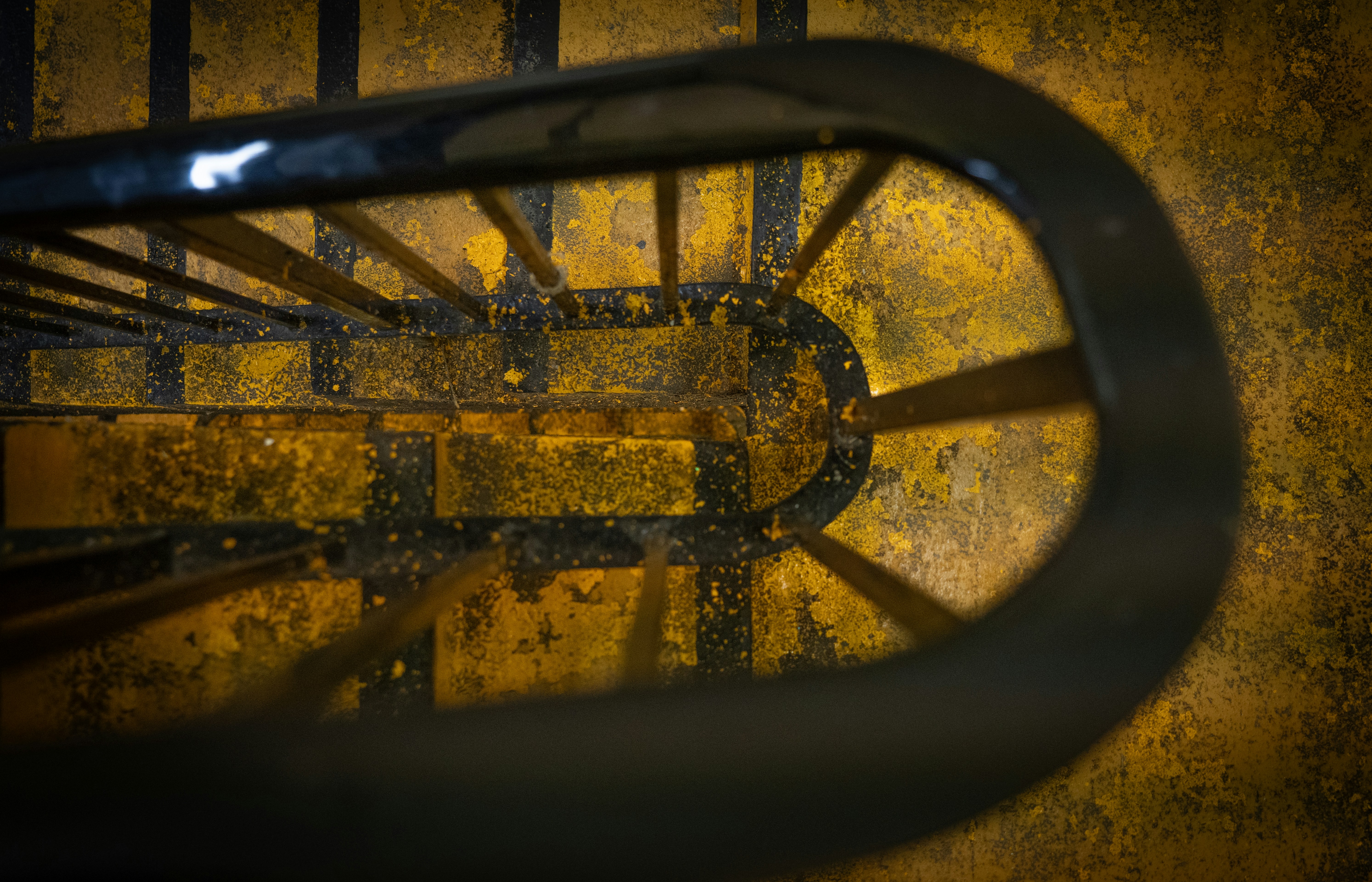 Amber Spiral: An Aerial Portrait of a Weathered Industrial Staircase