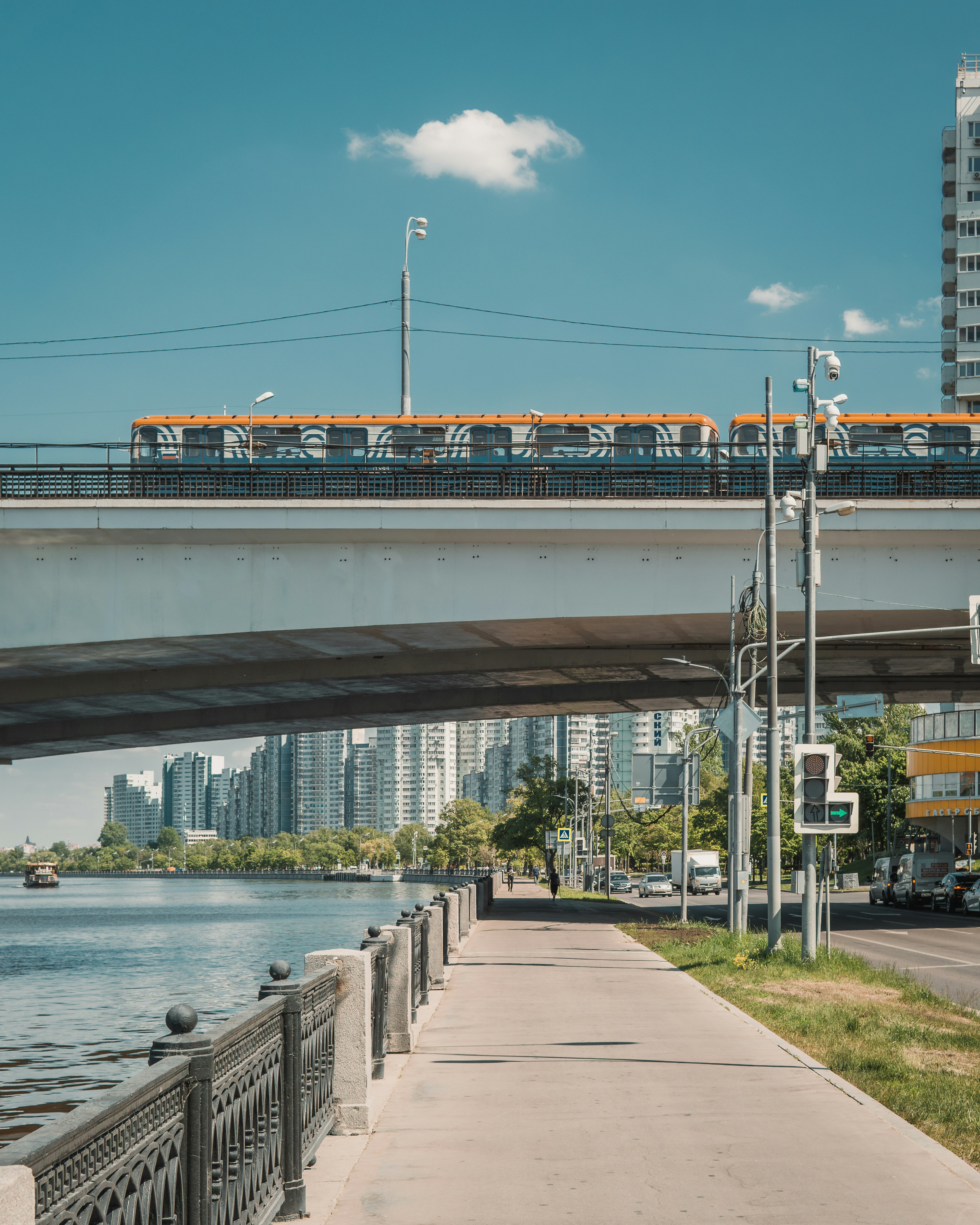 Orange tram tracing a line above the riverfront skyline