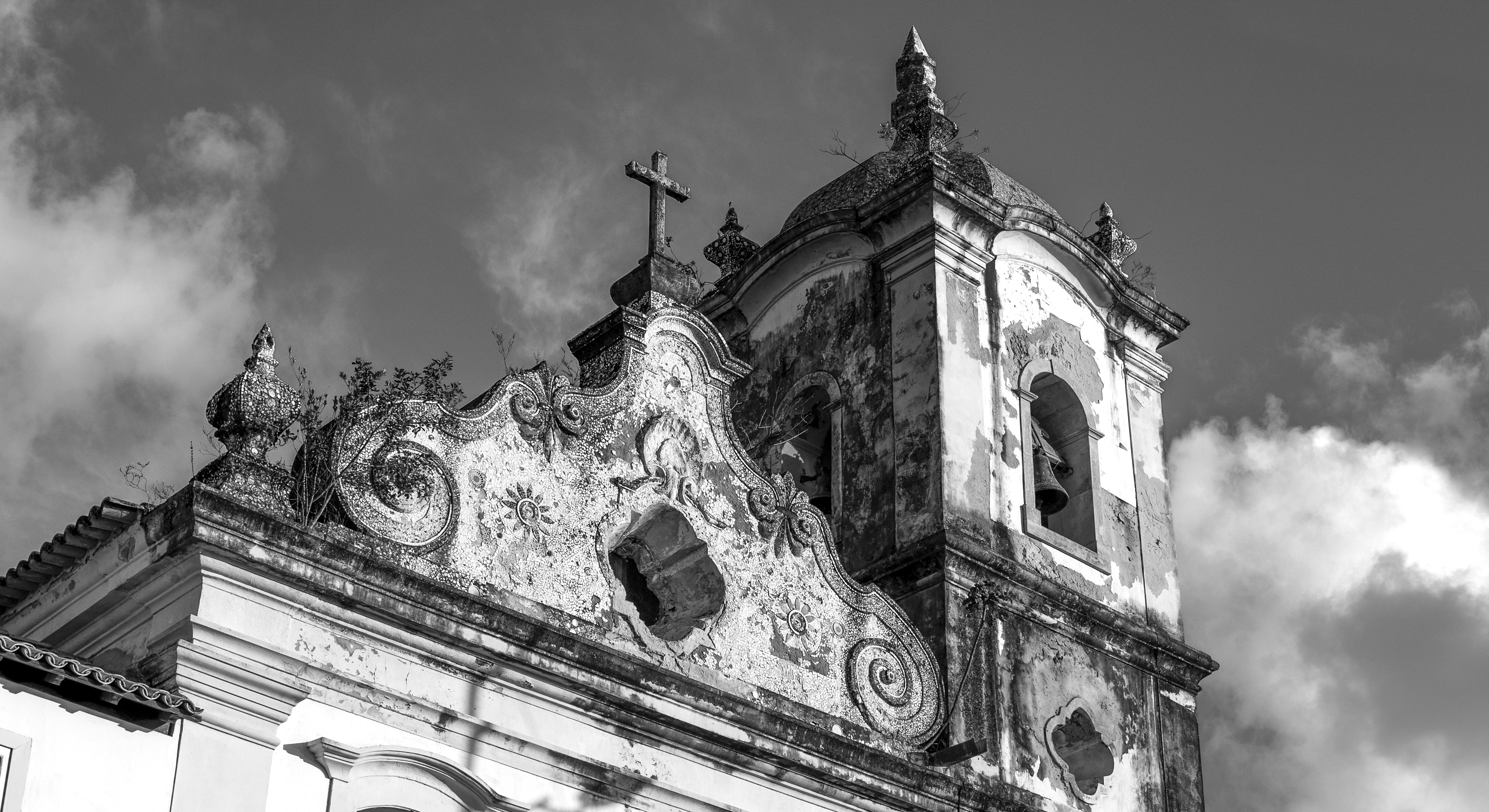 Ornate baroque church façade against a cloudy sky.