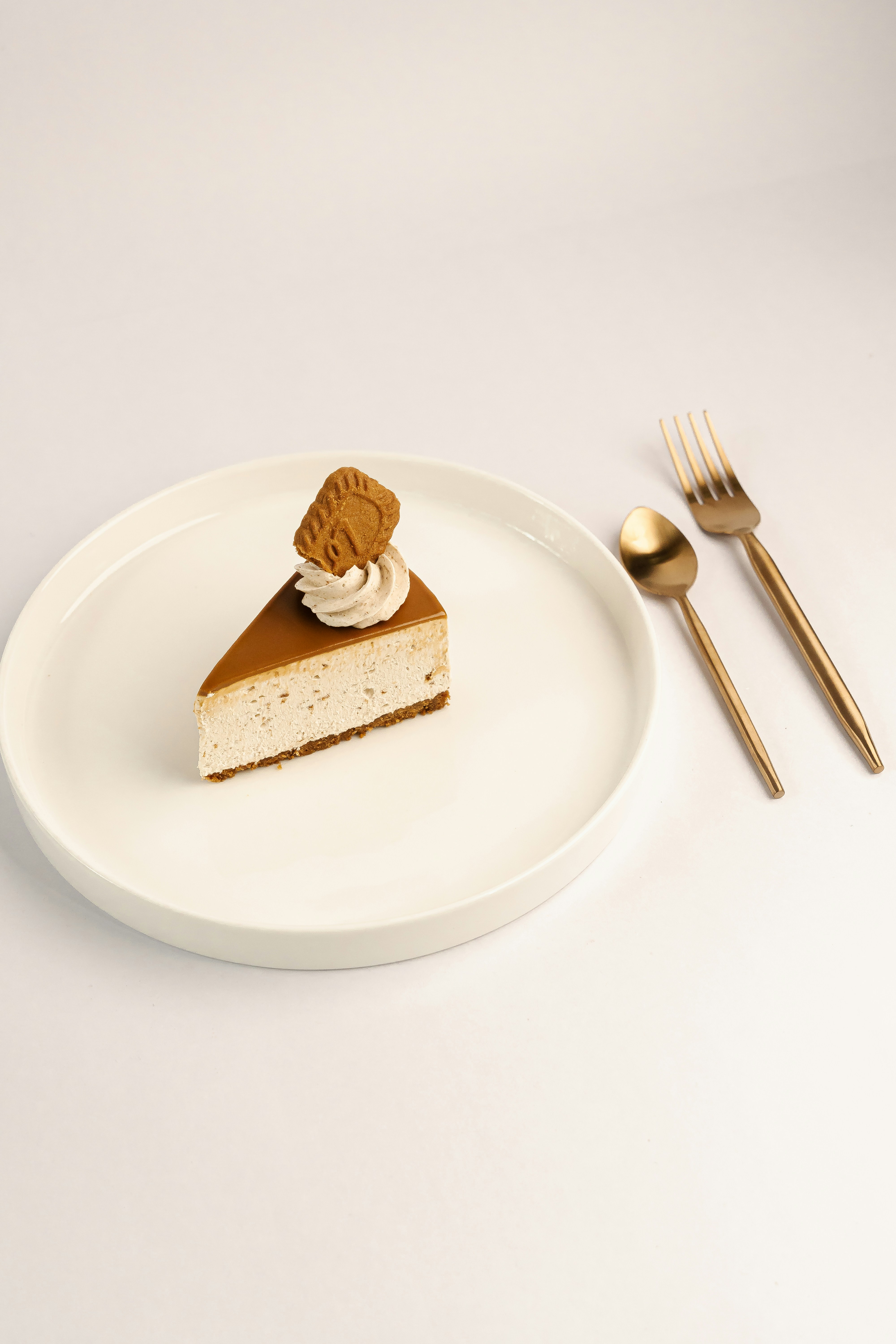 Caramel-kissed Cheesecake Slice on a Minimal White Stage