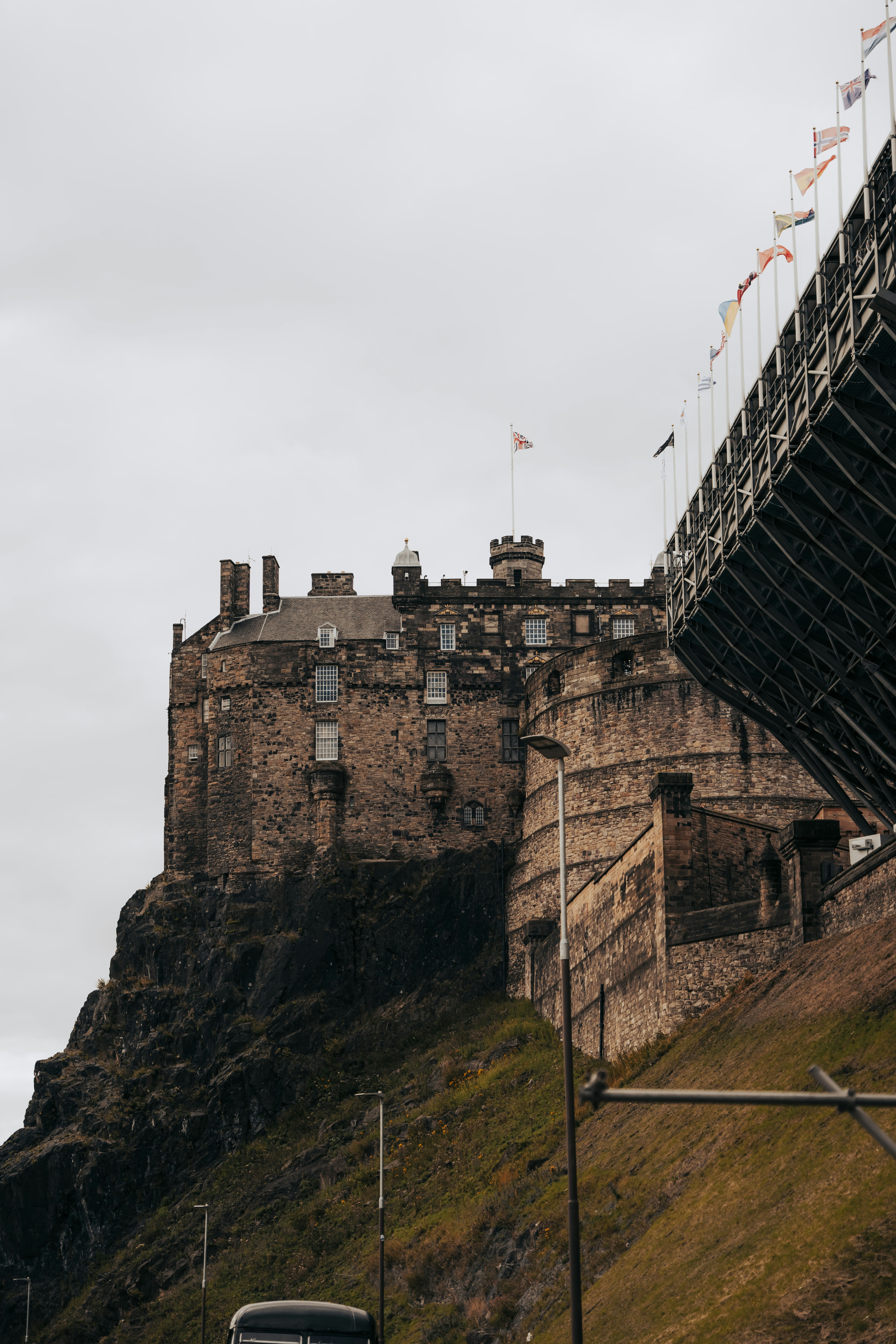 Cliffside Fortress and Flagged Bridge: Stone Sentinel Over the Sea