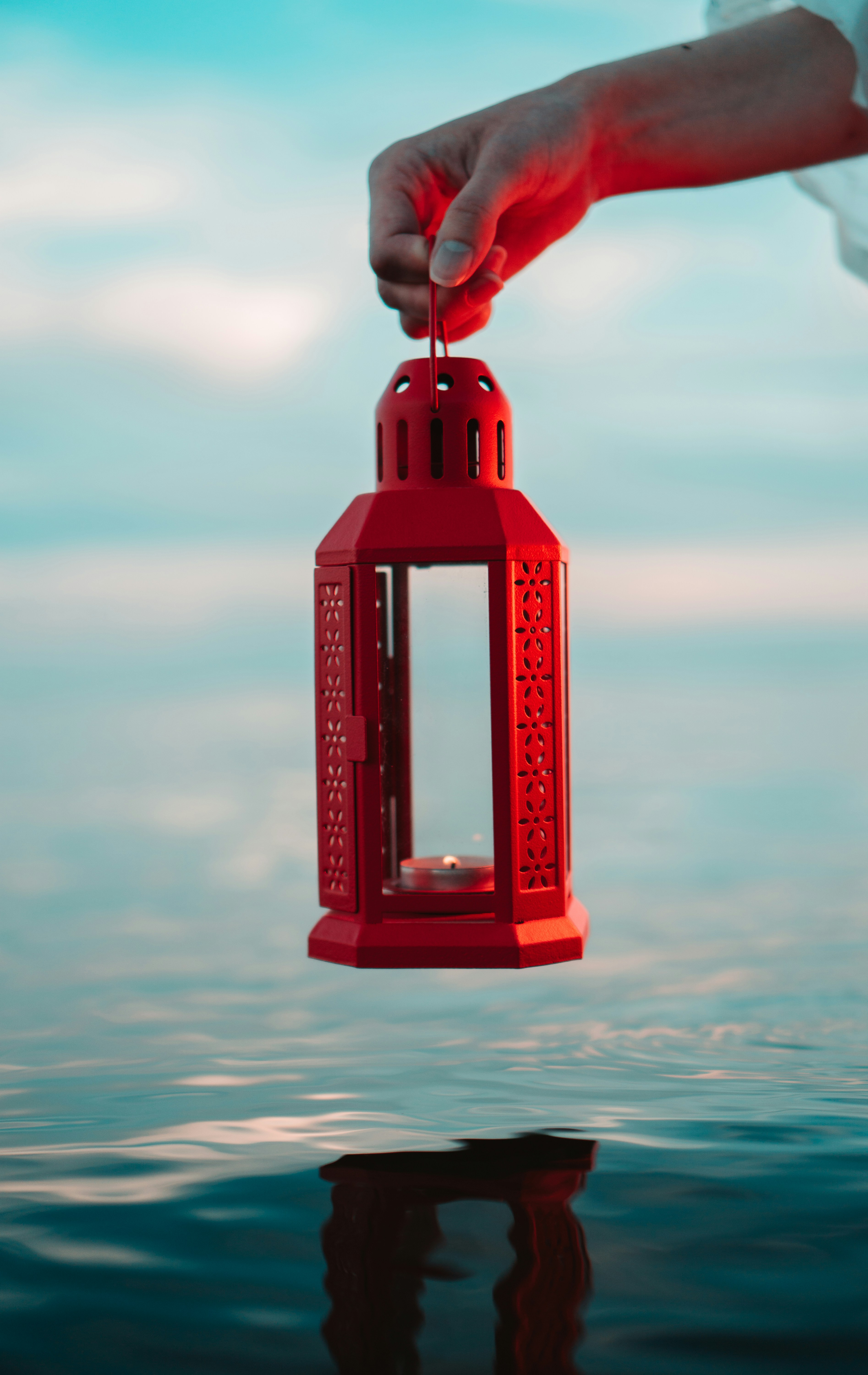 Crimson Lantern Hovering Over a Glassy Sea