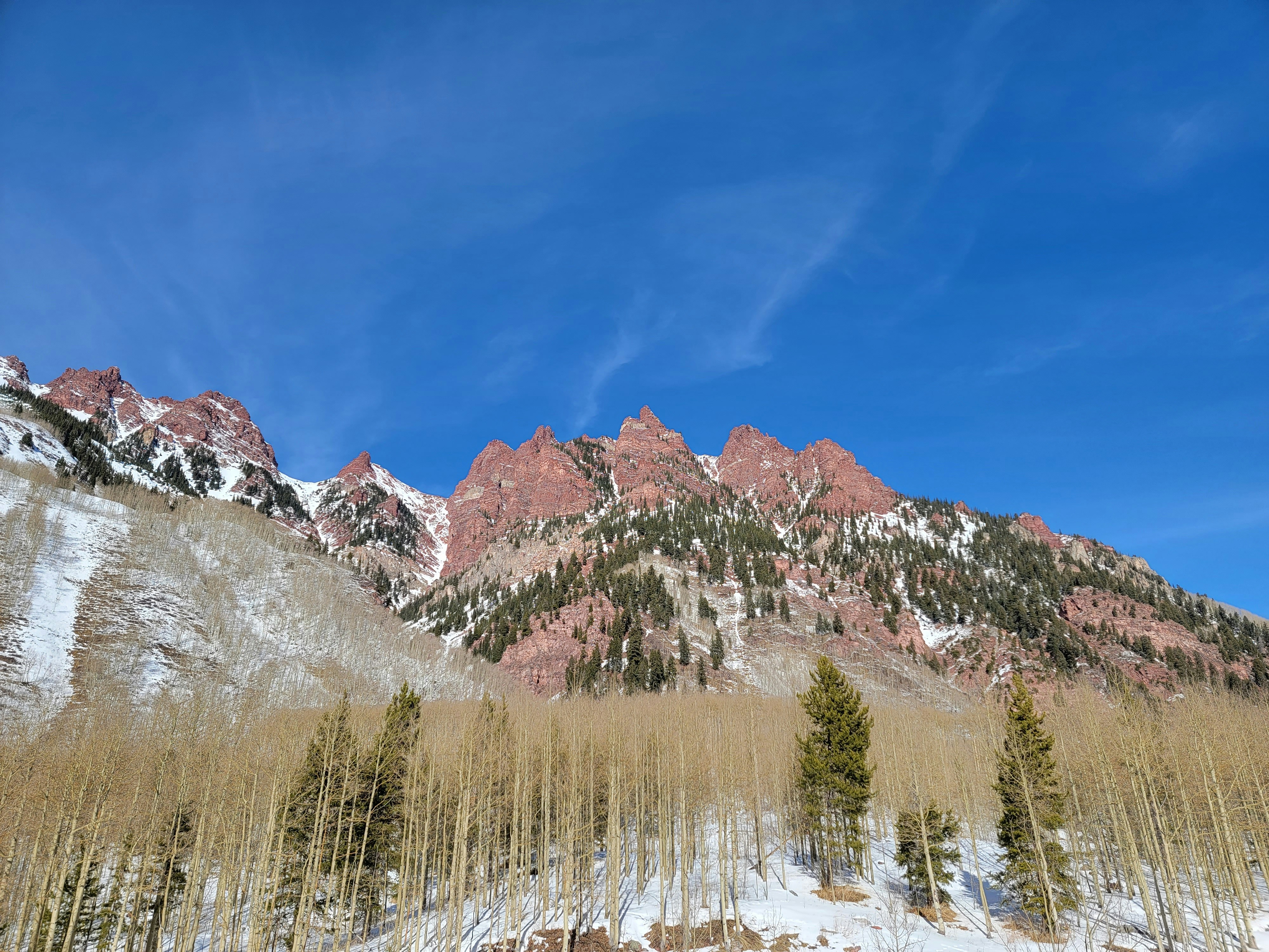 Crimson Peaks under a Cerulean Sky: Alpine Winter Panorama