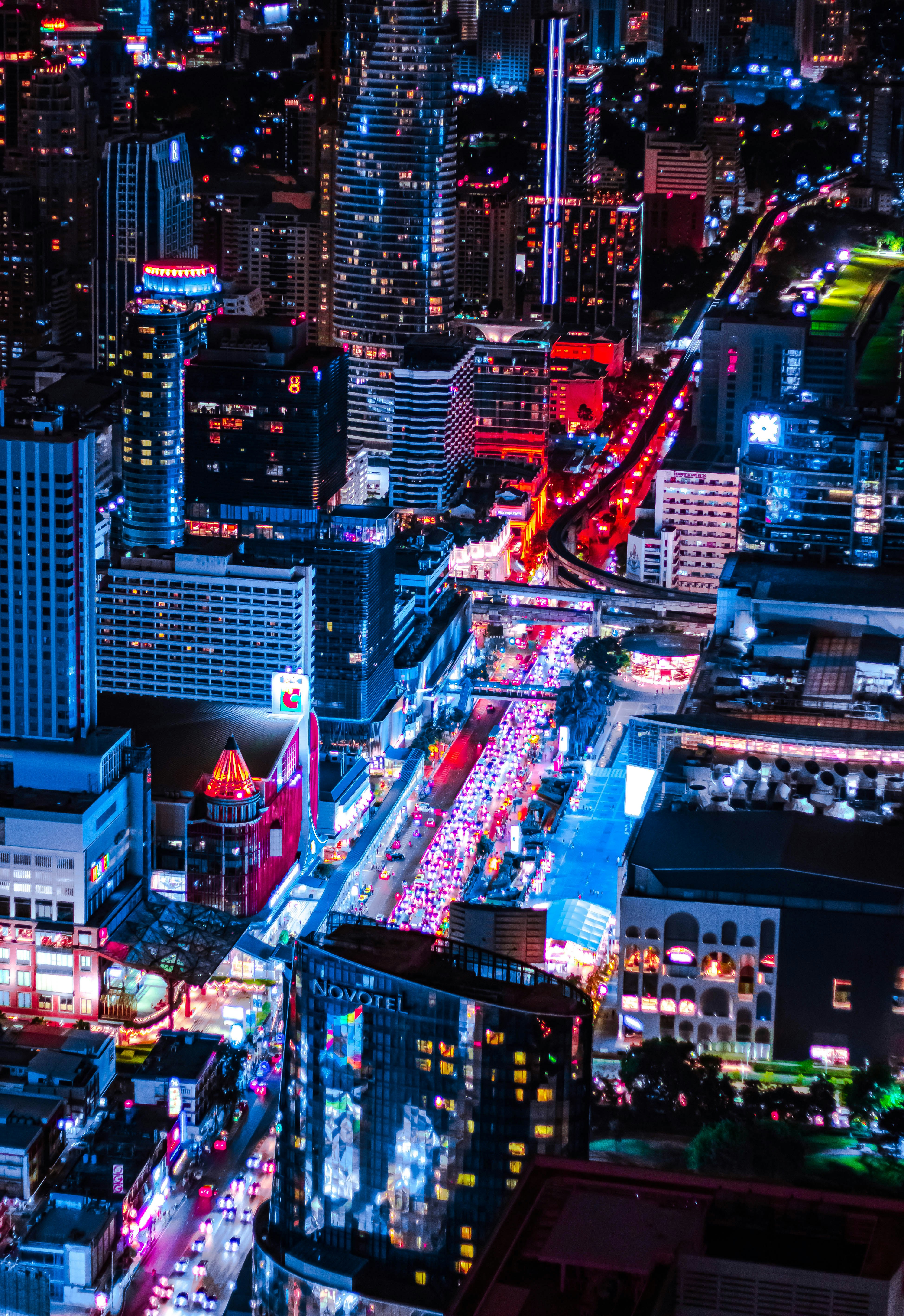 Midnight Neon Grid: A Bird's-Eye Portrait of Downtown Traffic and Towers