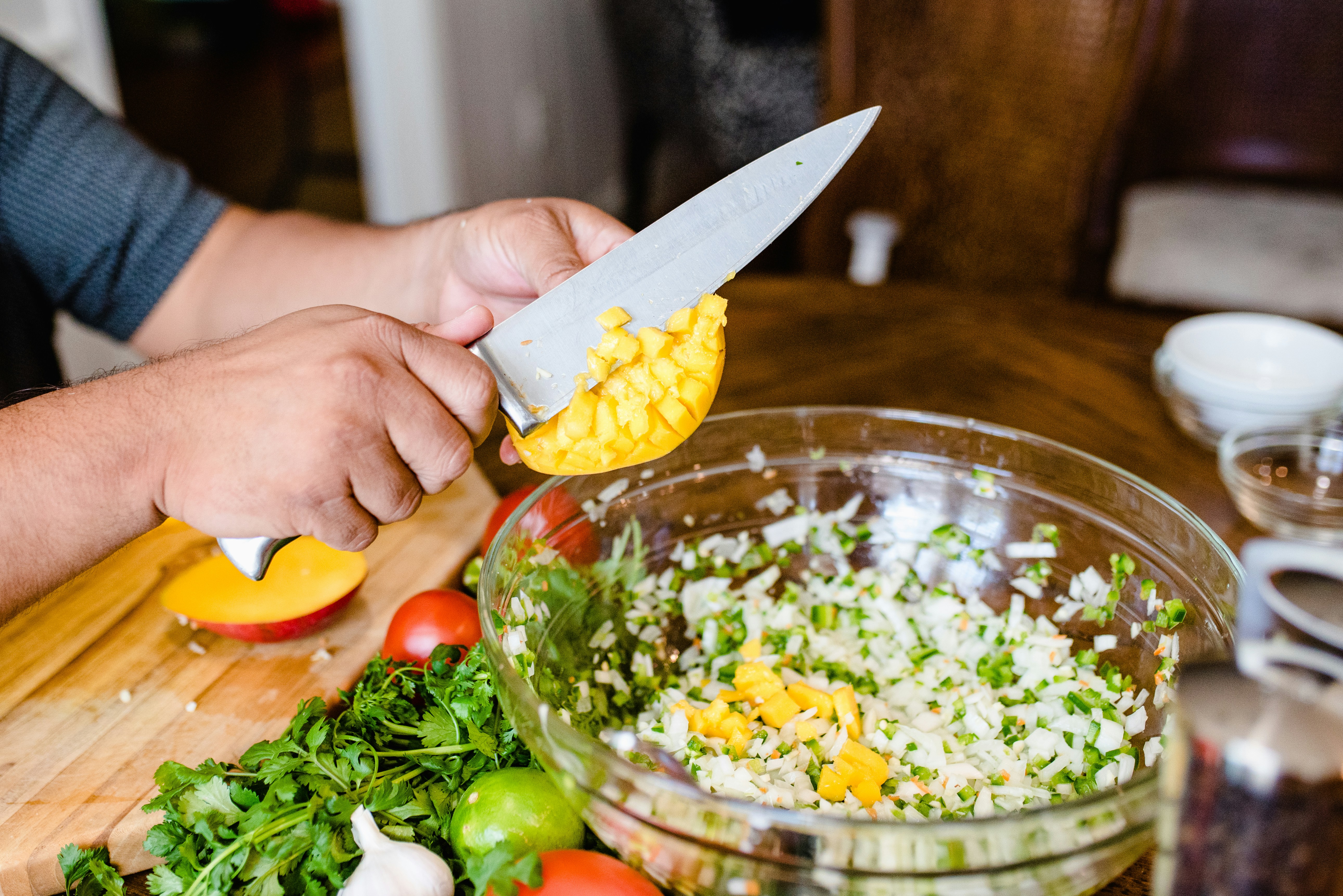 A person cutting up vegetables on a cutting board photo – Free Food ...