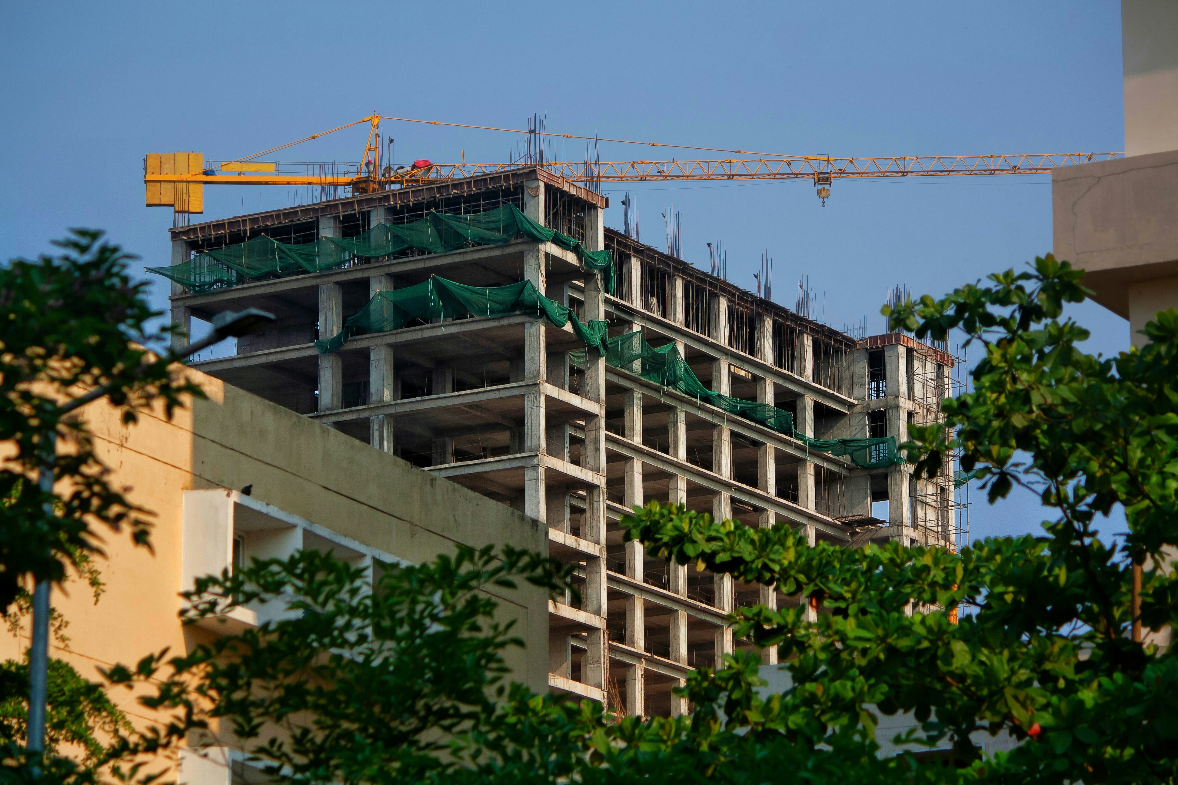 A building under construction with a crane in the background photo ...