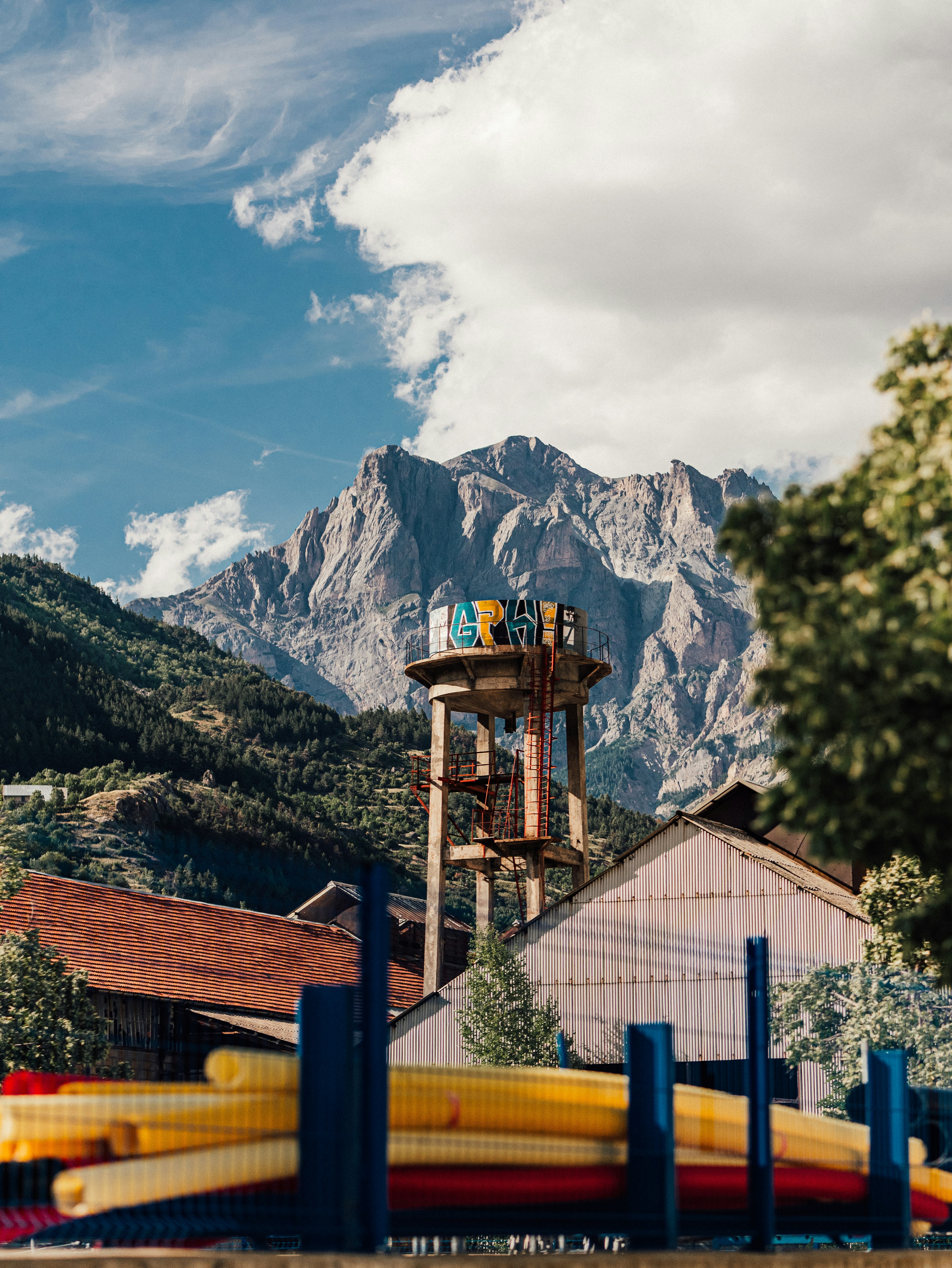 Graffiti-Topped Platform Against Alpine Peaks
