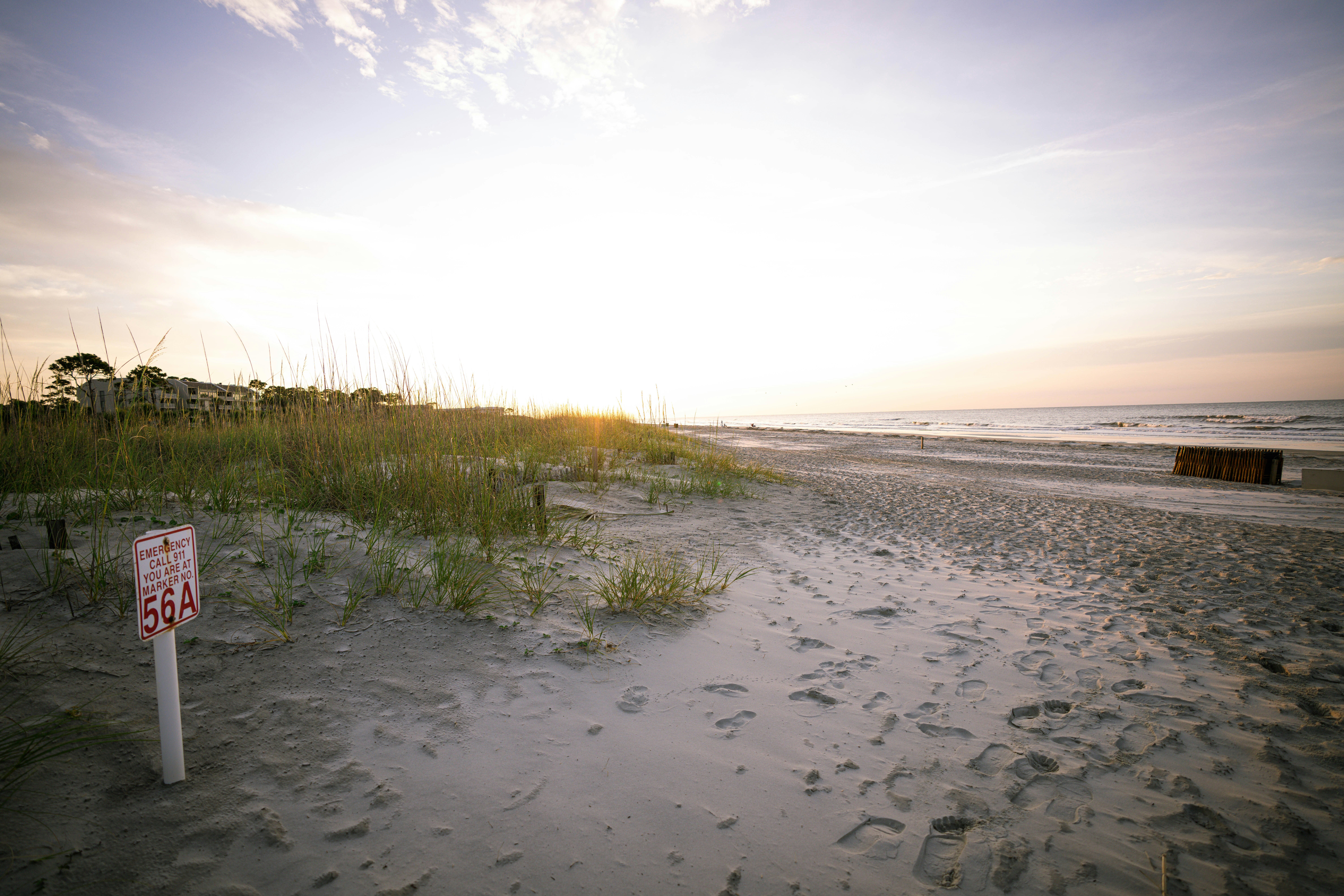 A sign on a beach near the ocean photo – Free Hilton head island Image ...