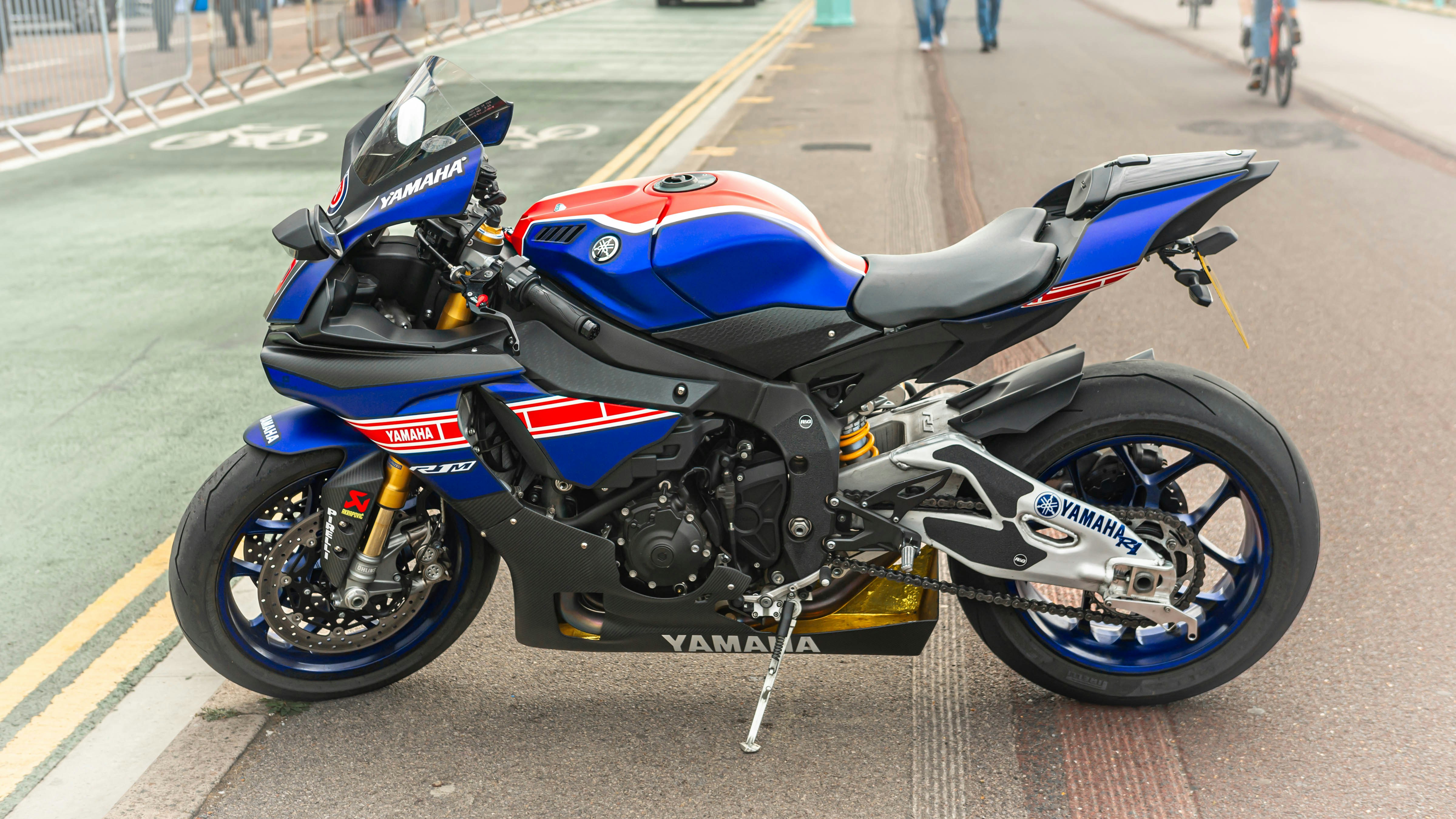 A blue and red motorcycle parked on the side of the road photo – Free ...