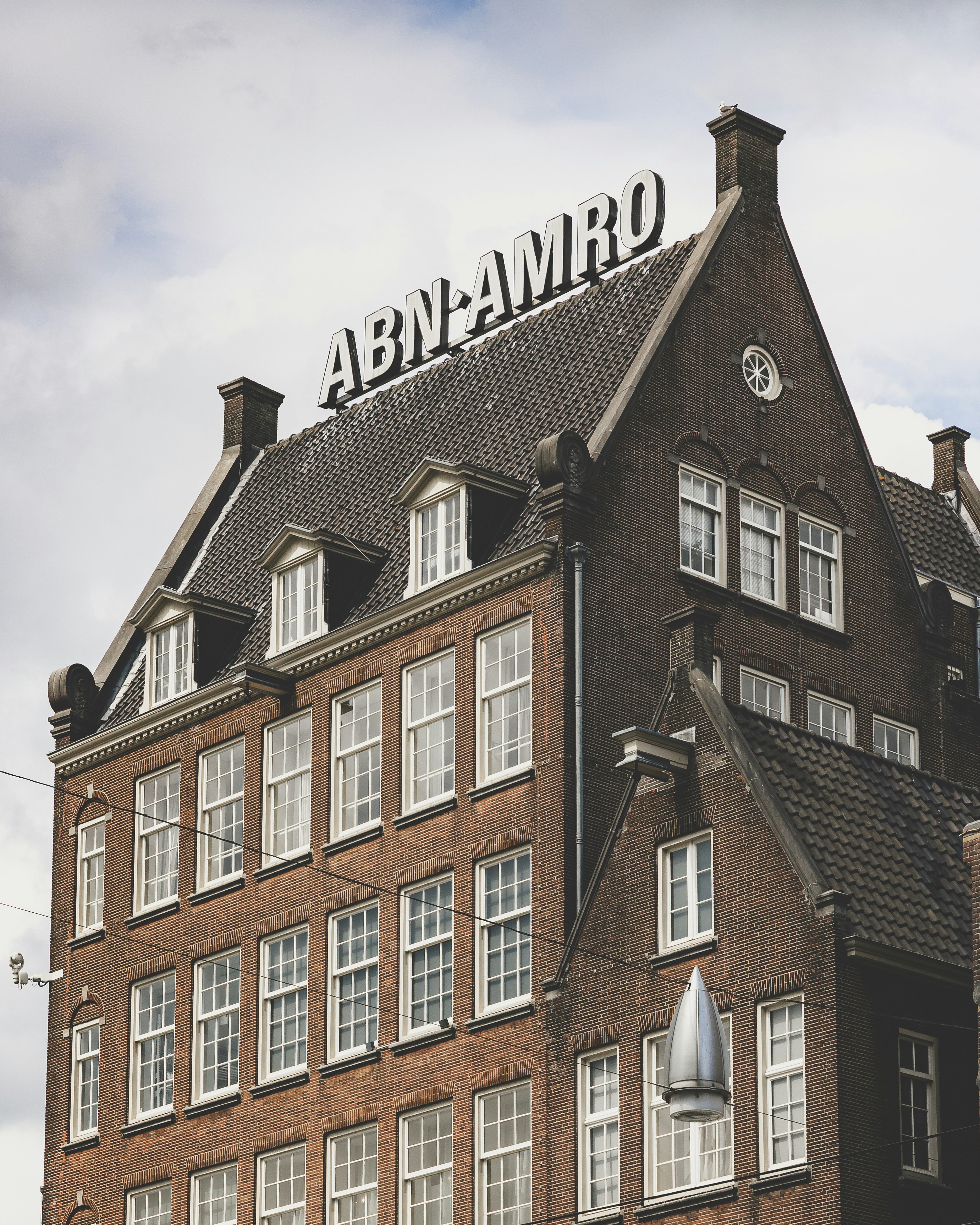 Brick Gable Under the ABN AMRO Sign: A Quiet City Facade