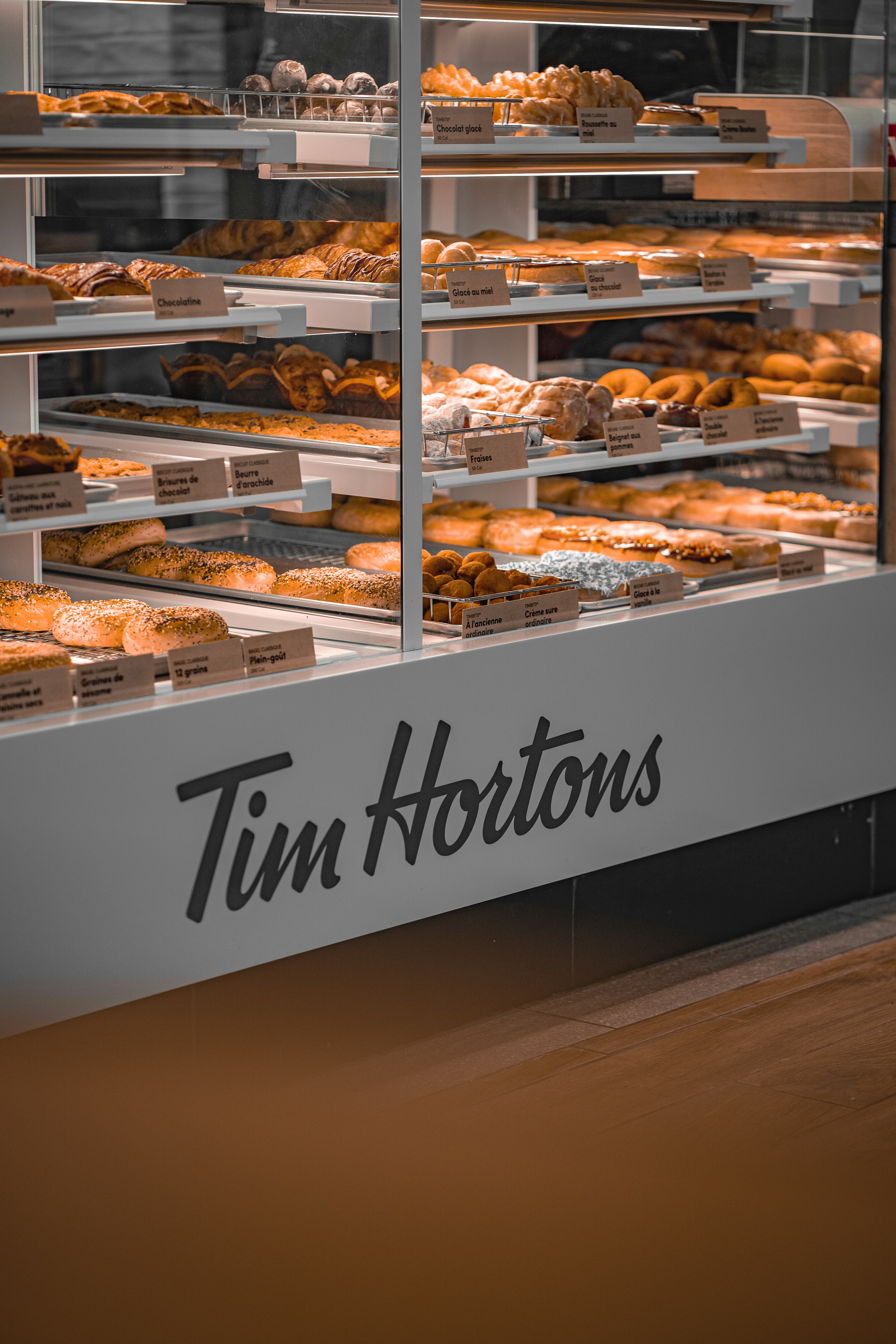 A display case filled with lots of donuts photo – Free Tim horton Image ...