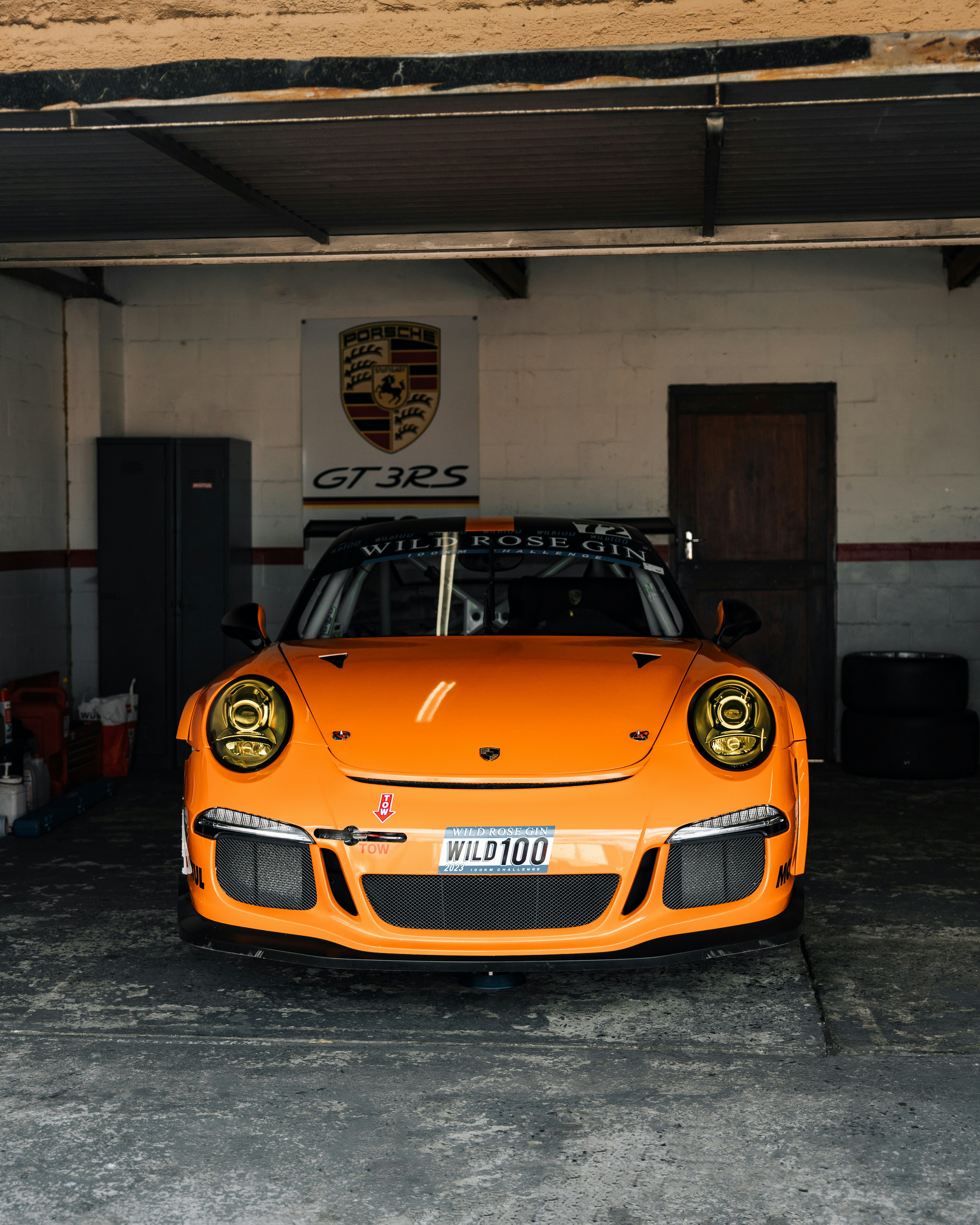 Amber Precision: Front-View Porsche GT3 RS in a Dim Garage