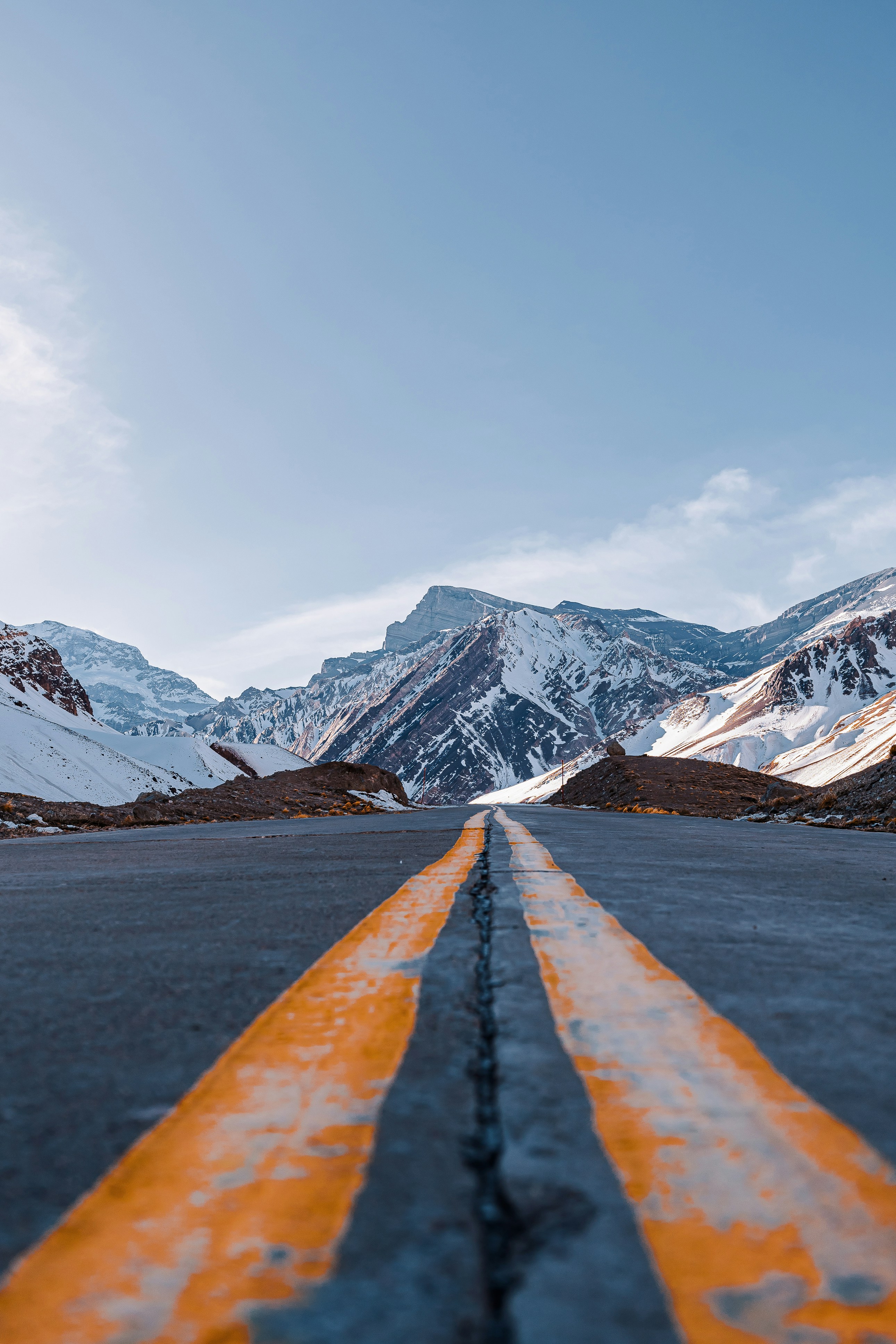 a yellow line on a road in the mountains