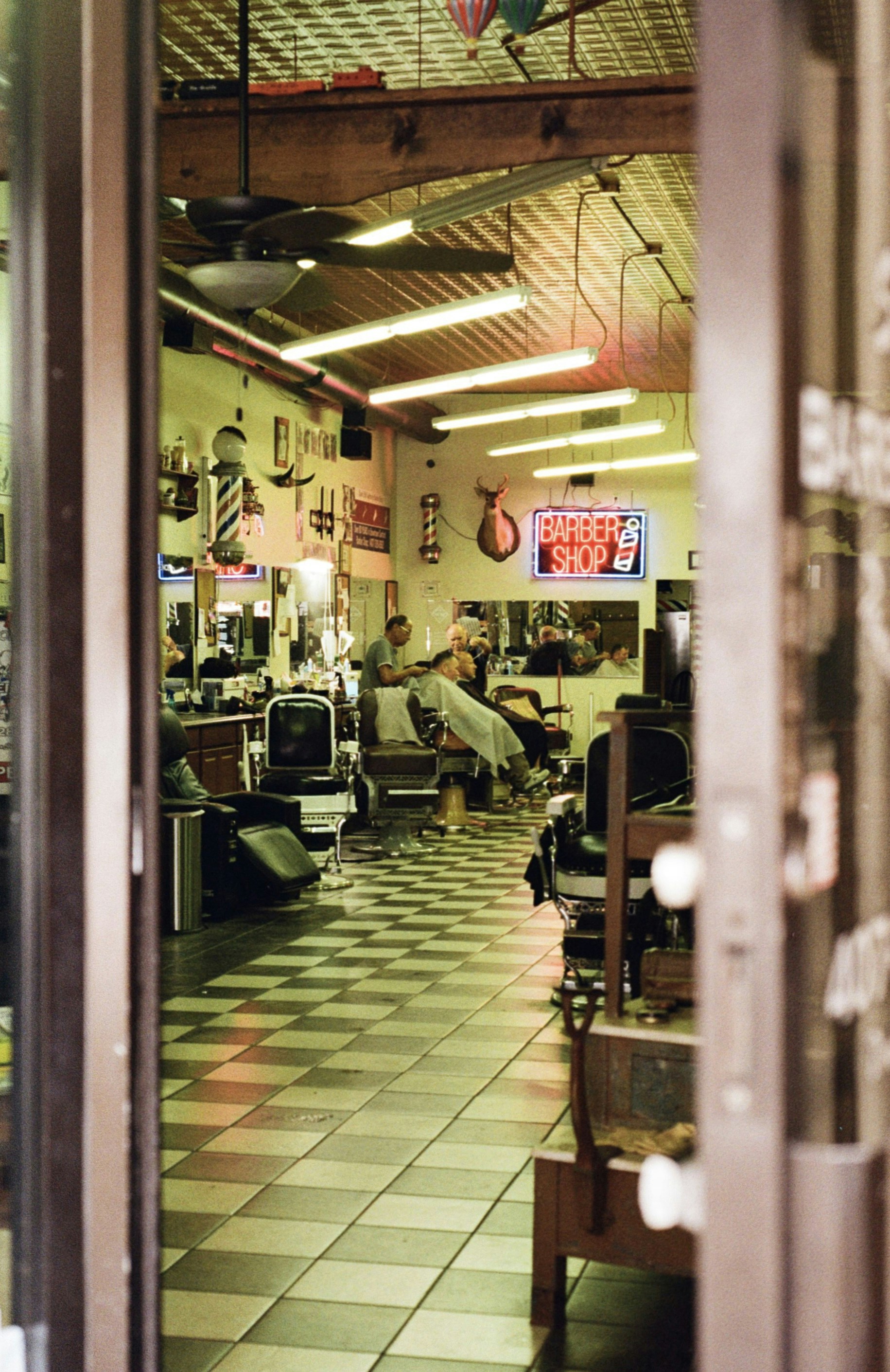 A barber shop with a checkered floor and tiled floors photo – Free Fl ...