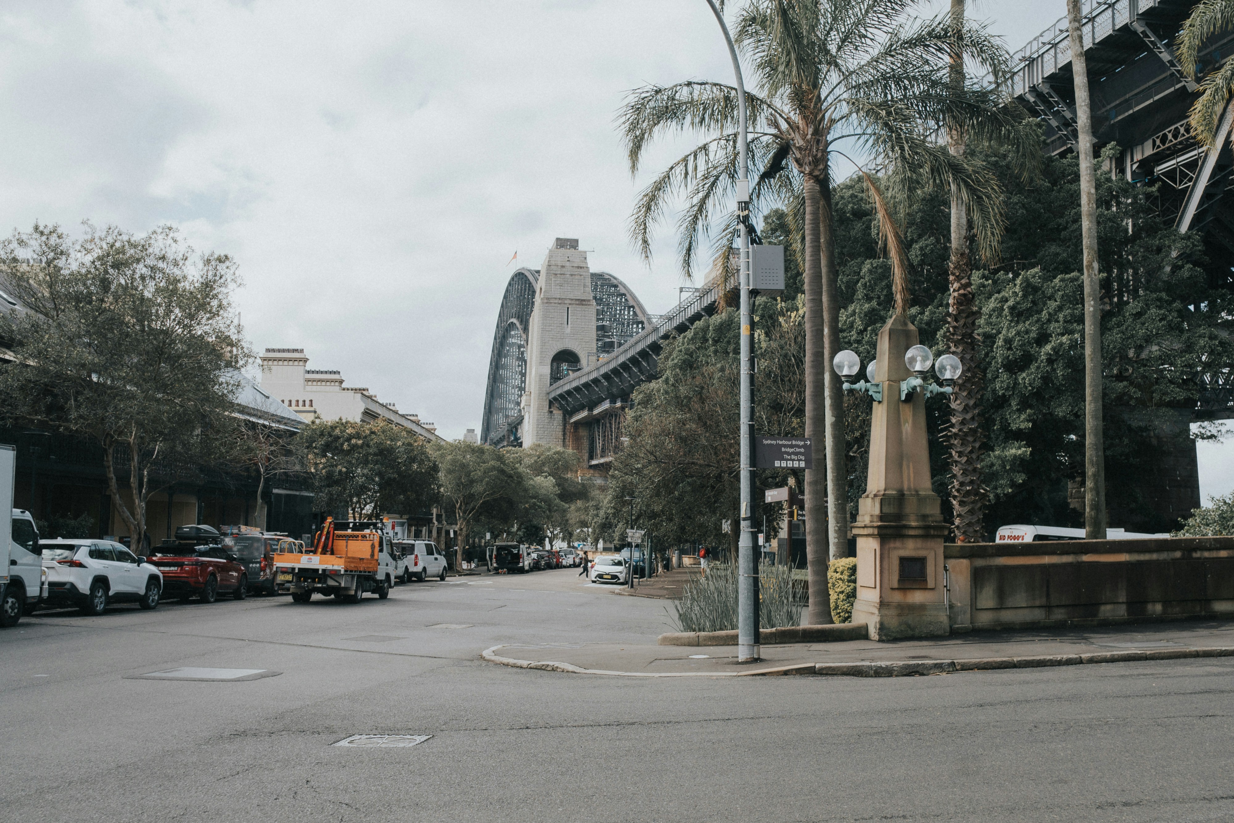 a street filled with lots of traffic next to tall buildings