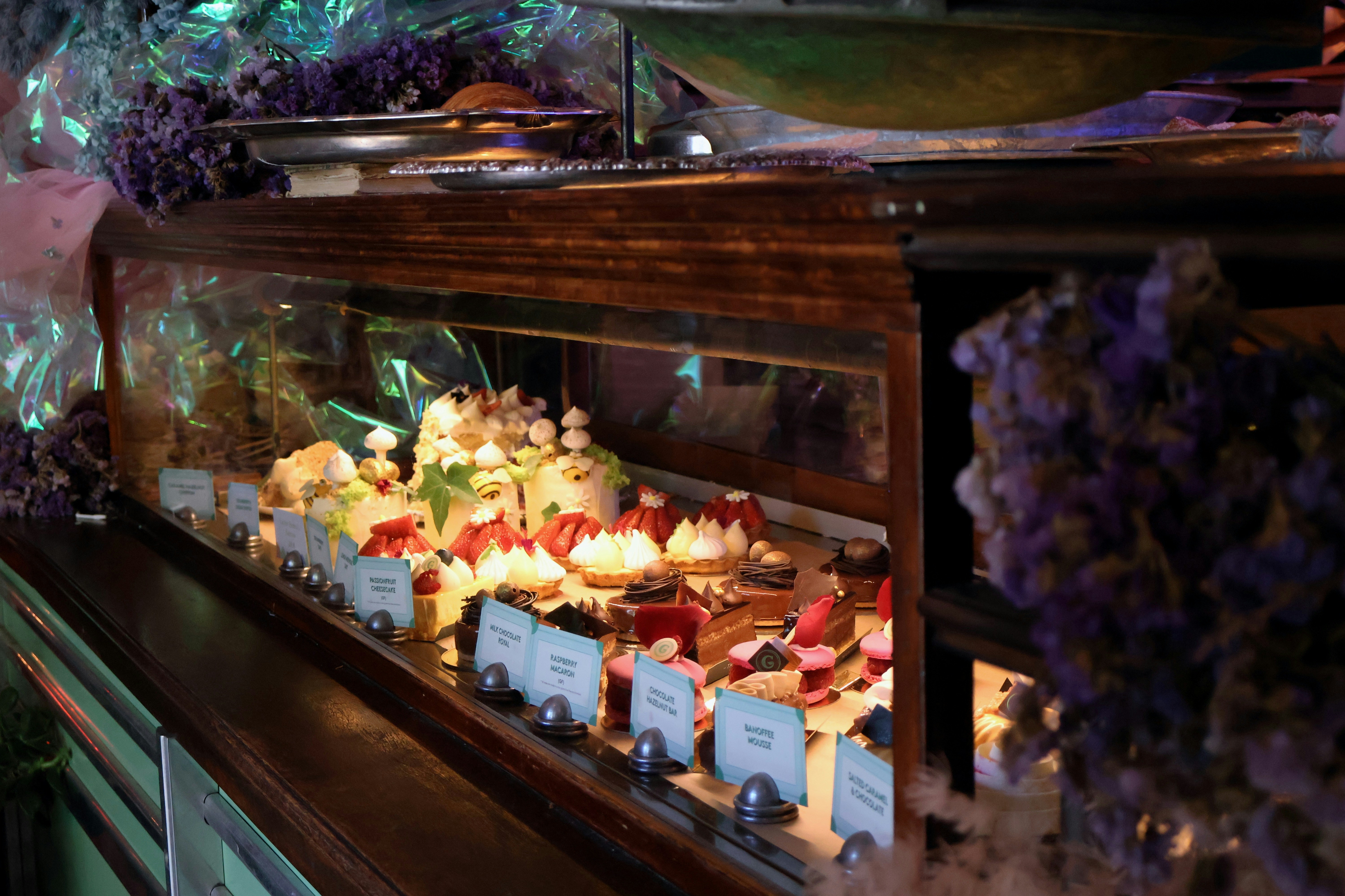 Neon-lit Pastry Parade Behind Glass