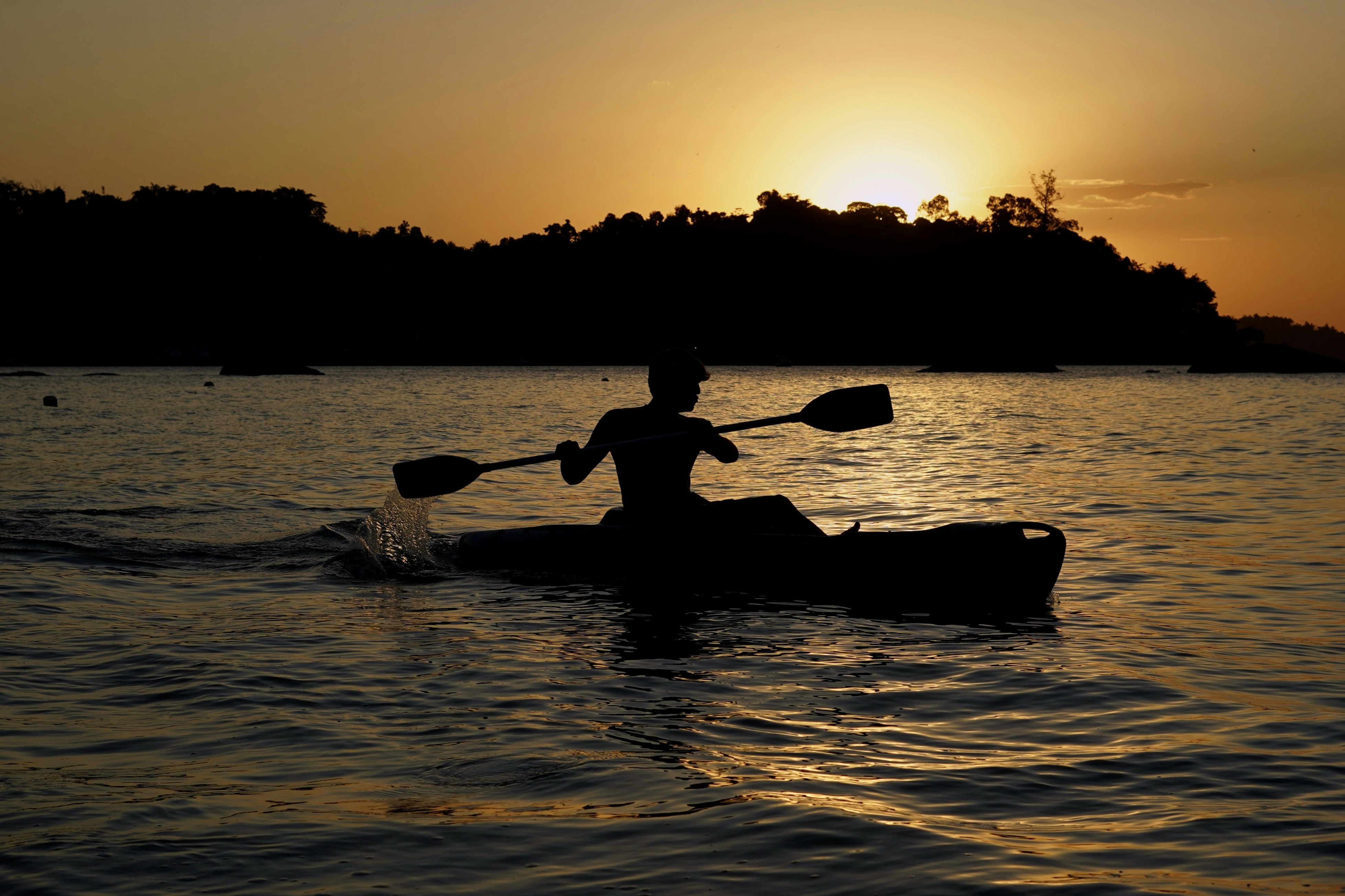 A person is paddling a canoe in the water photo – Free Man Image on ...