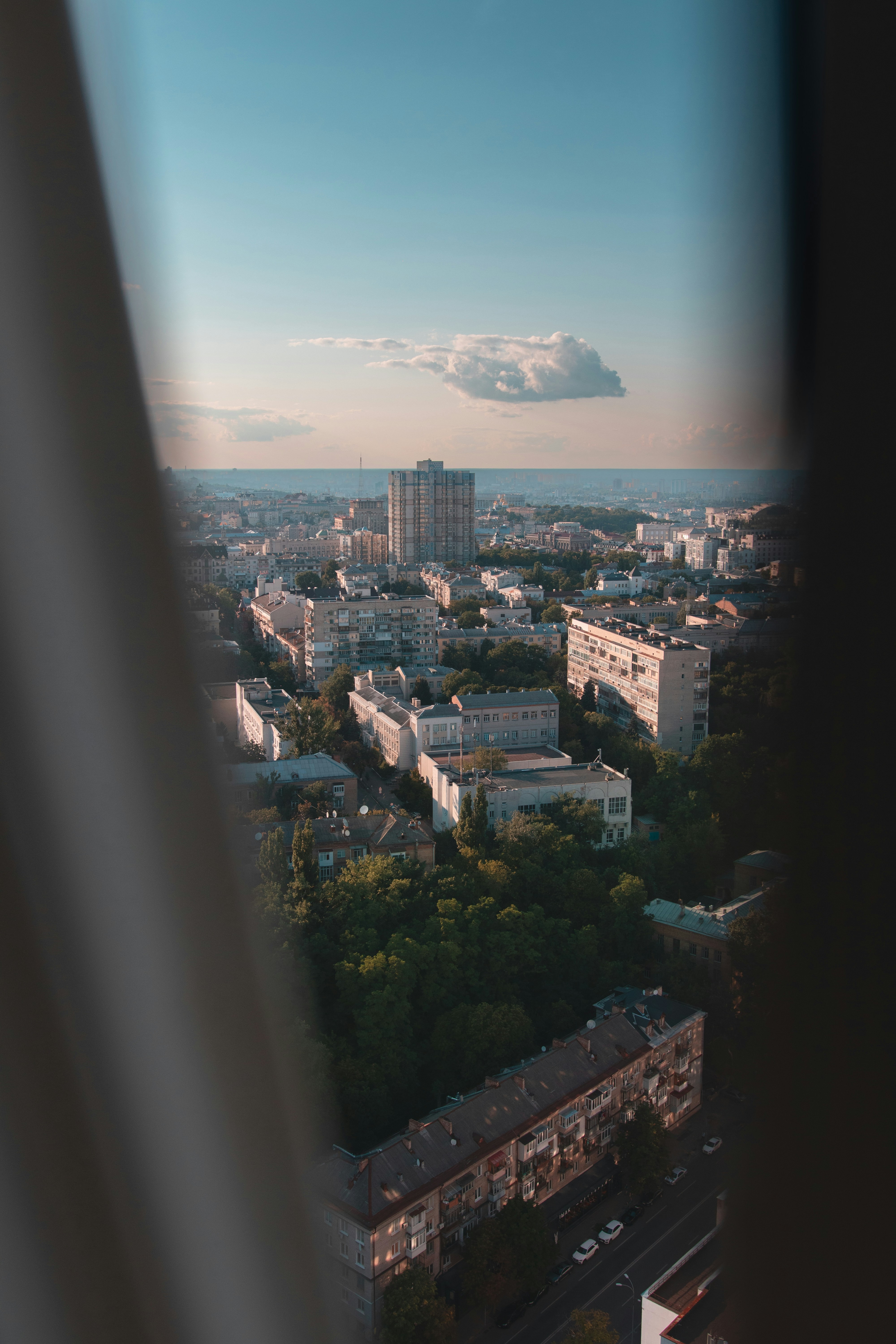 Curtain-Framed Dusk: A Quiet City Grid Unfolds