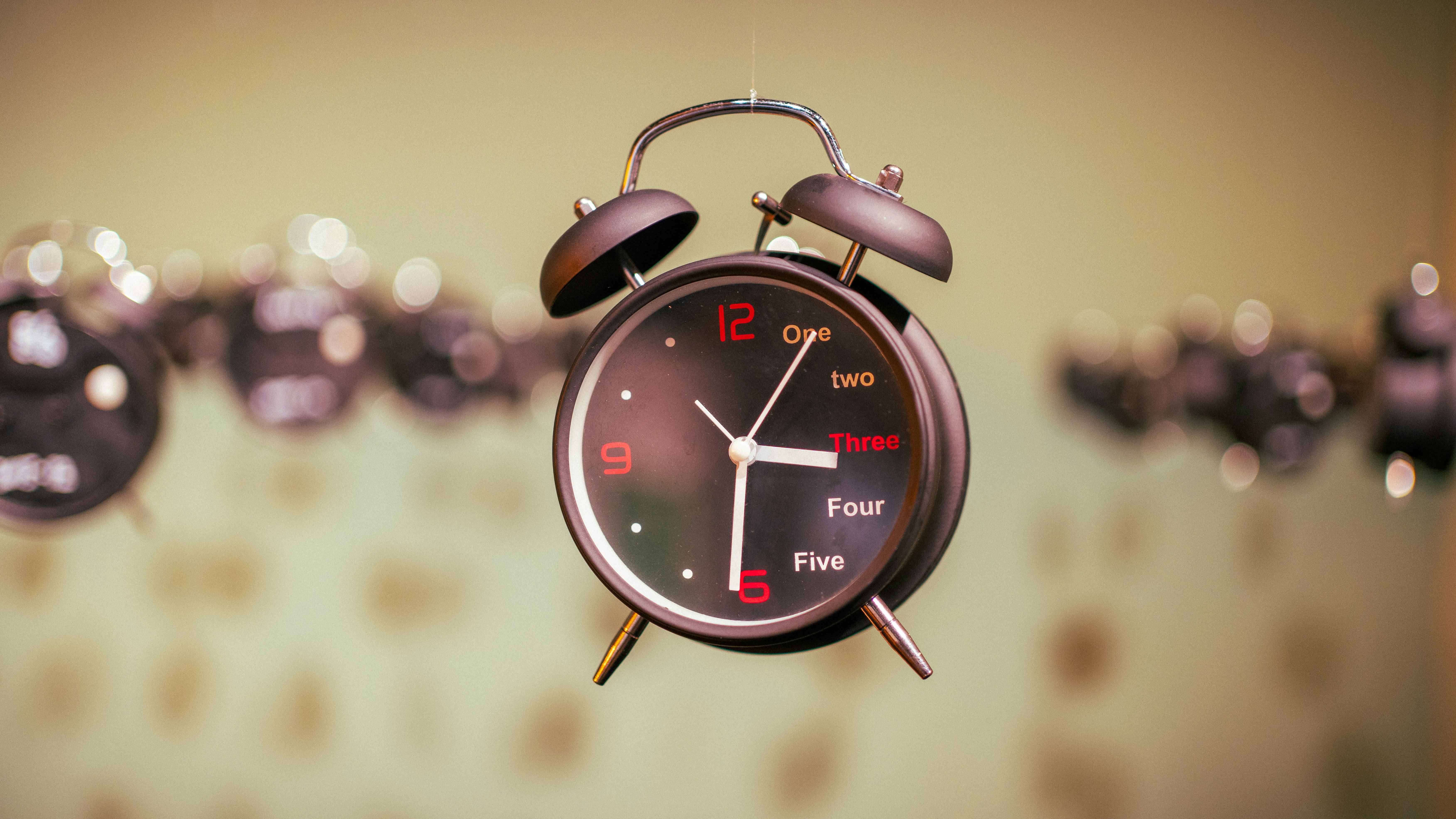 An alarm clock hanging from the ceiling in a room photo – Free Clock ...
